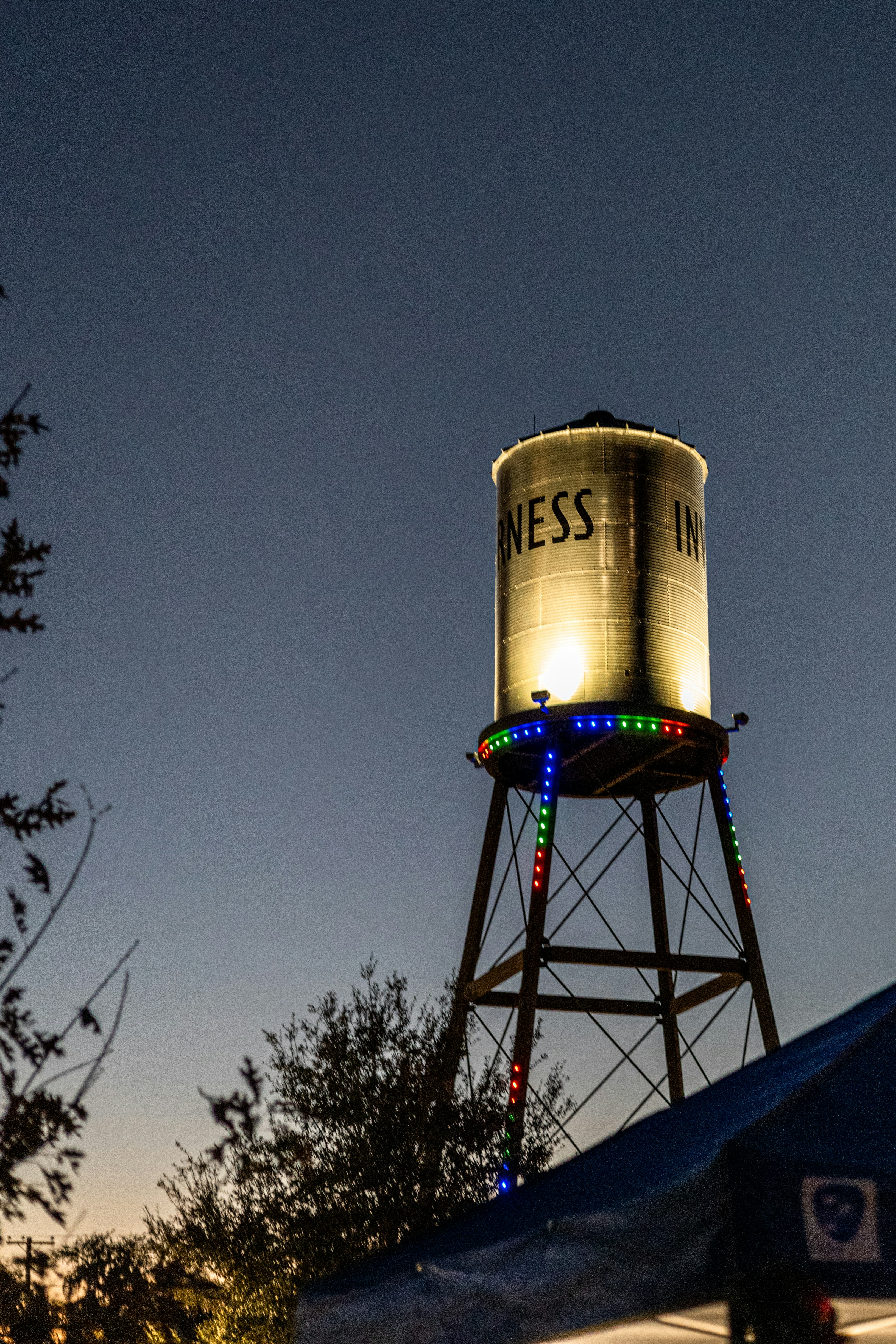 Water Tower Glow: Nighttime Neon Illumination Over a Quiet Town