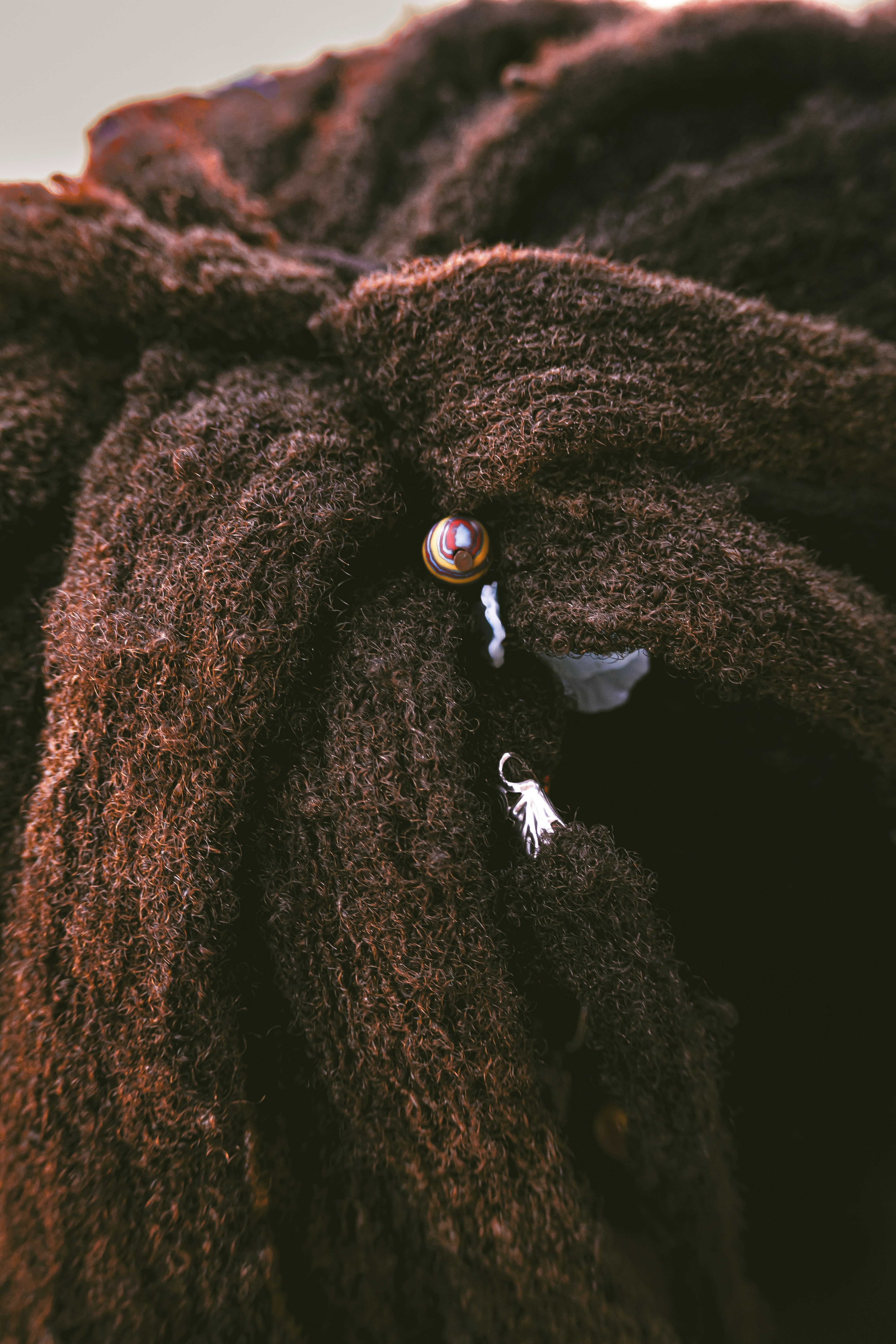 Amber Bead Adrift in a Coil of Chocolate Dreadlocks