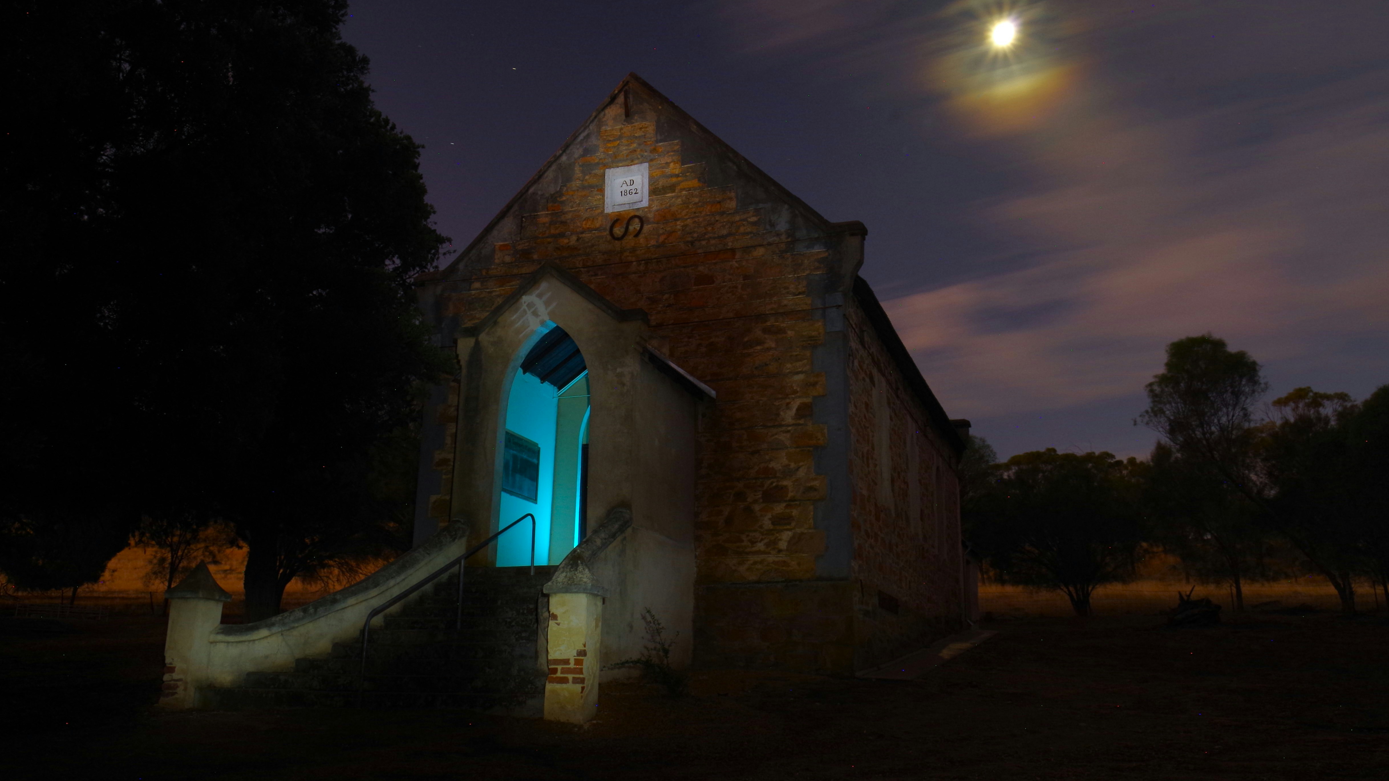 A spooky church lit up at night. photo – Free Moon Image on Unsplash
