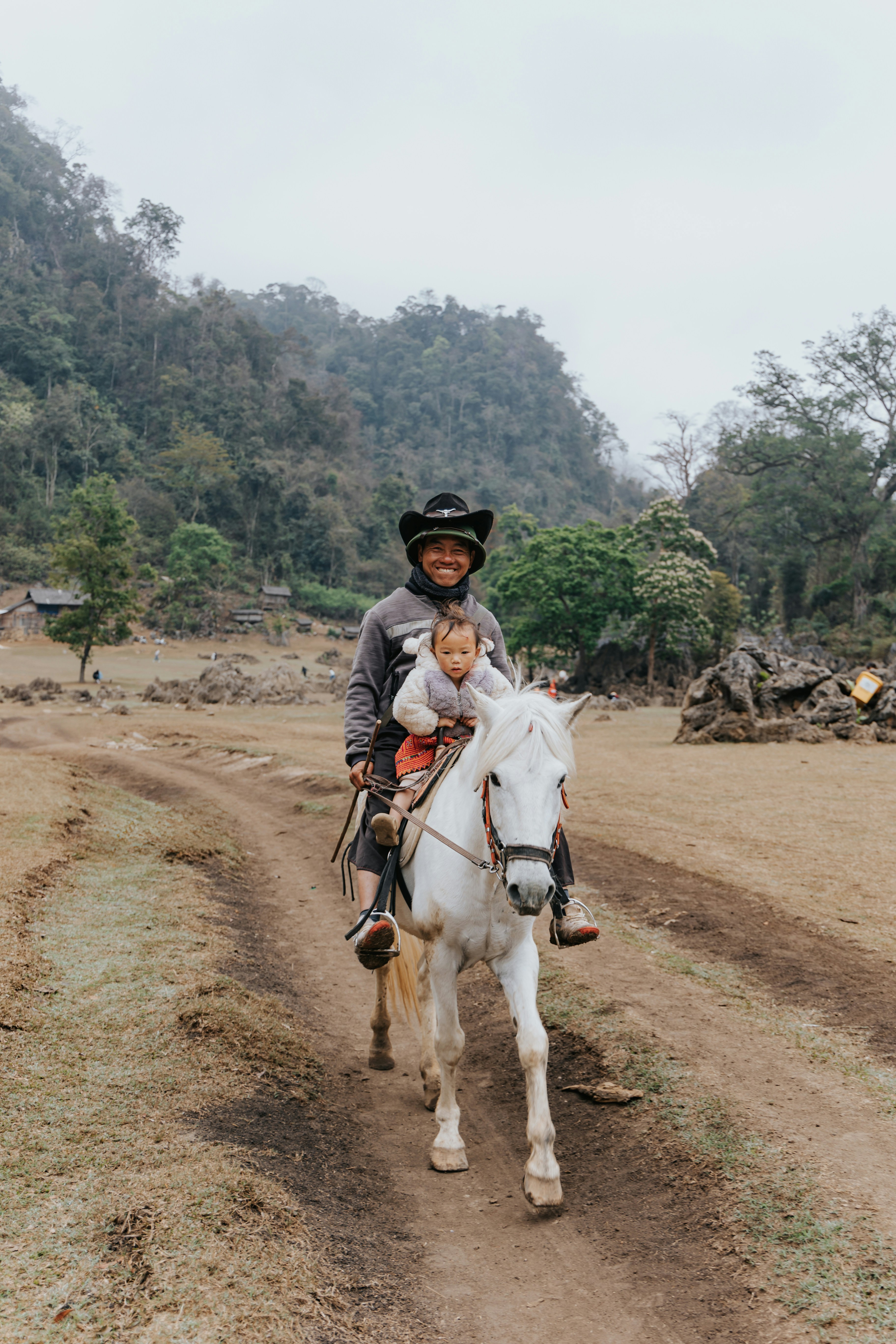 White Steed, Quiet Bond: A Rural Ride with a Little Passenger