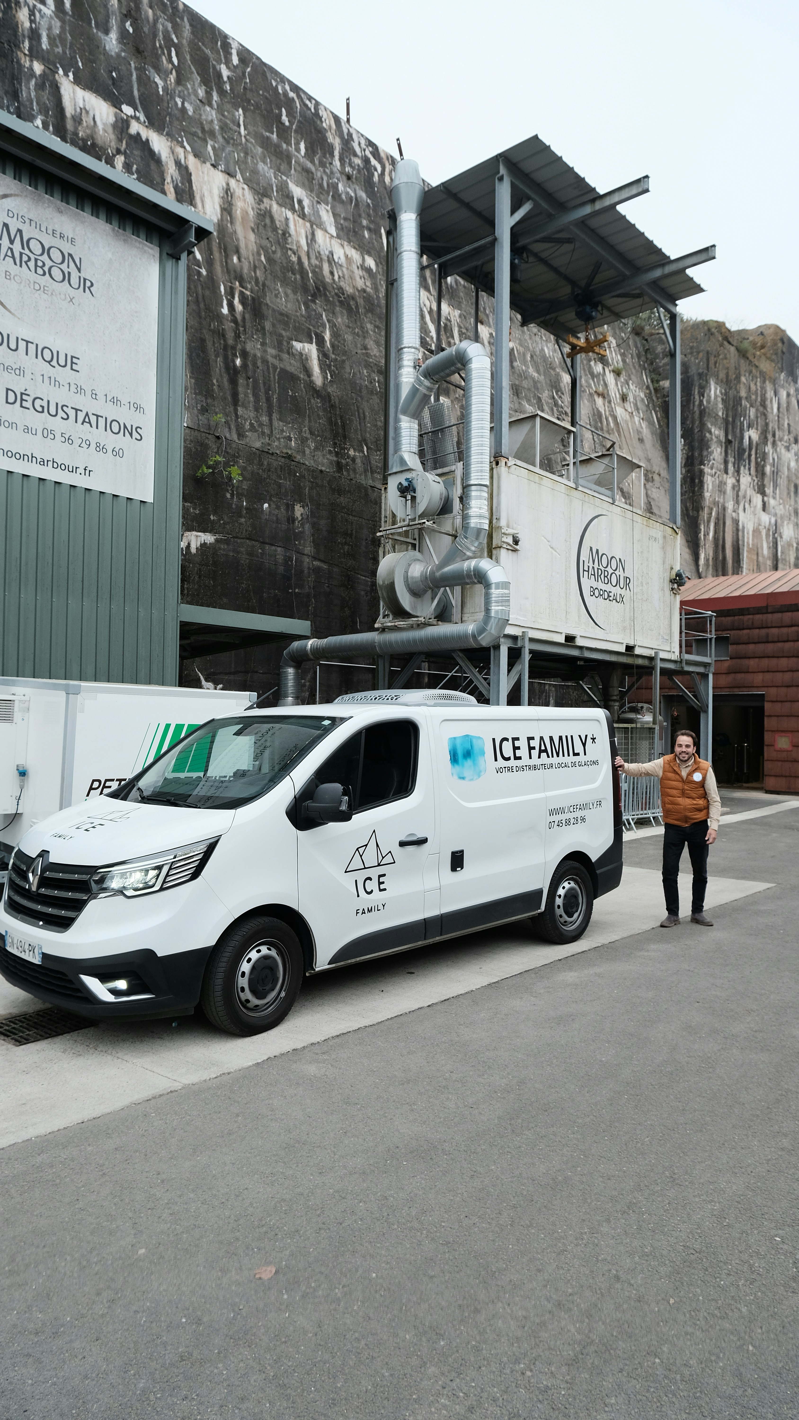 ICE FAMILY Logistics at Moon Harbour: White van beside weathered piping and a lone worker