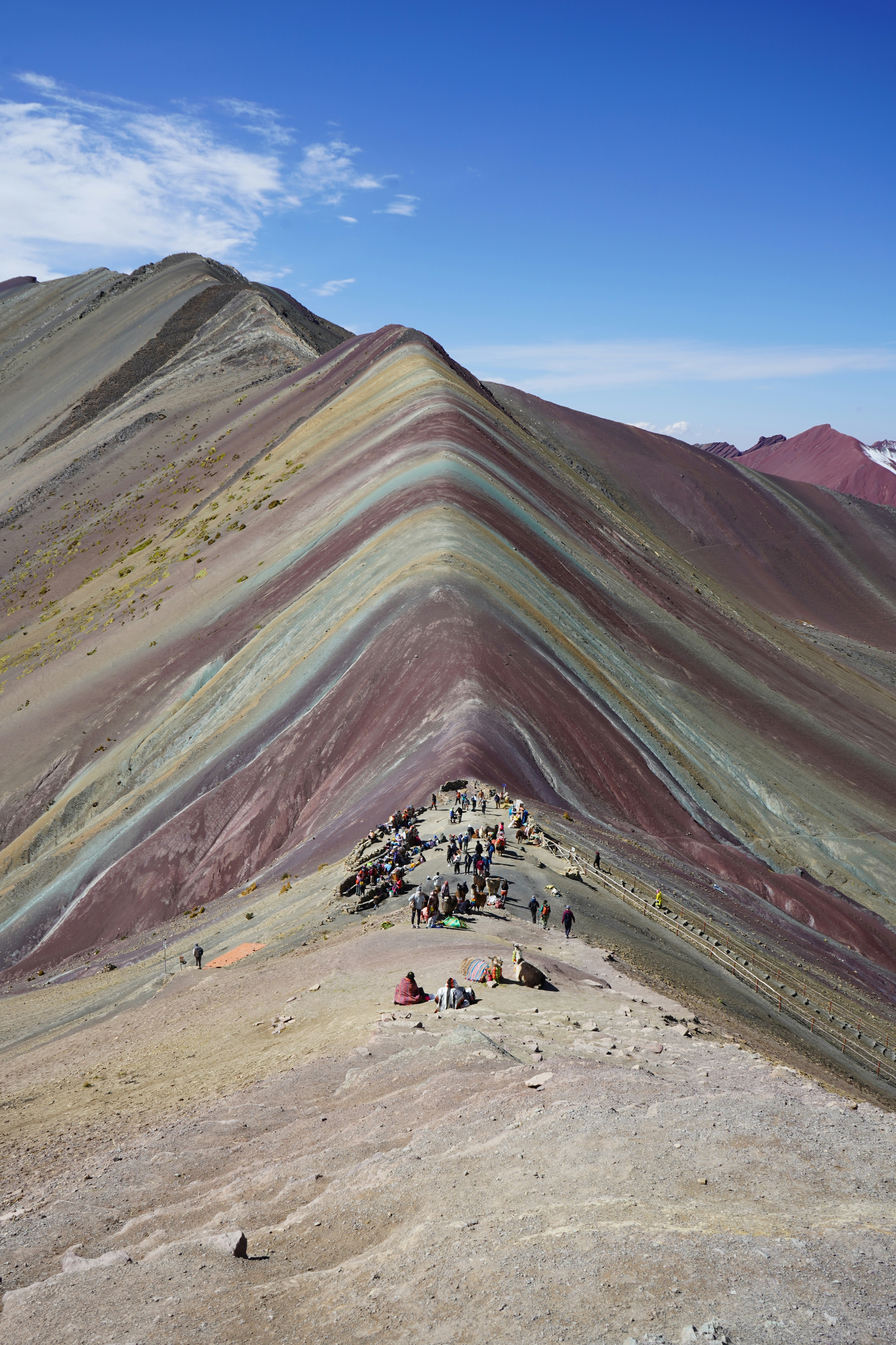 Rainbow mountain in peru with visitors.
