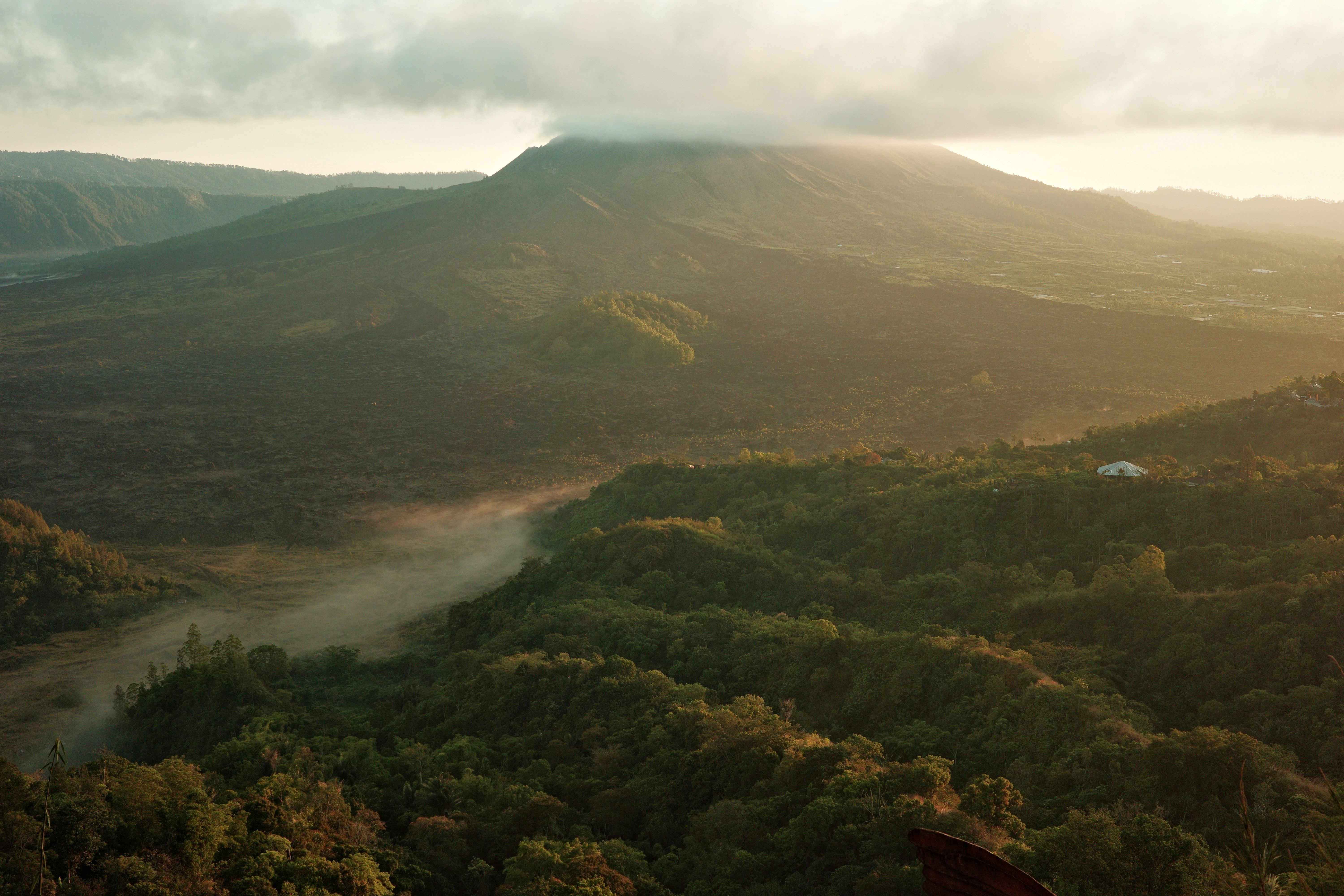 Dawn over the Caldera Ridge: Forest, Mist, and a Cloud-Capped Summit