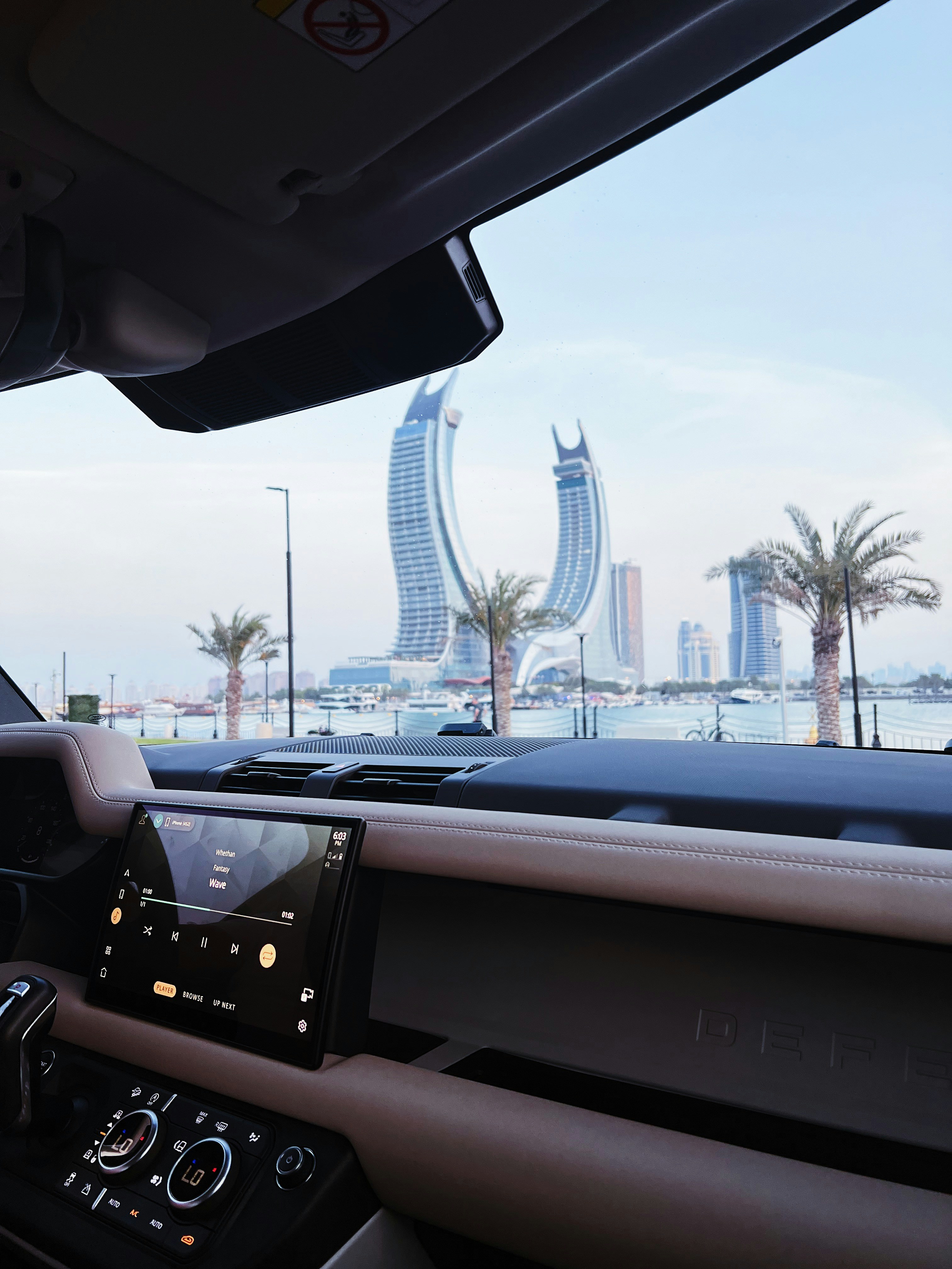Drive-by Mirage: Twin Curves along Dubai Marina Framed by a Car Window