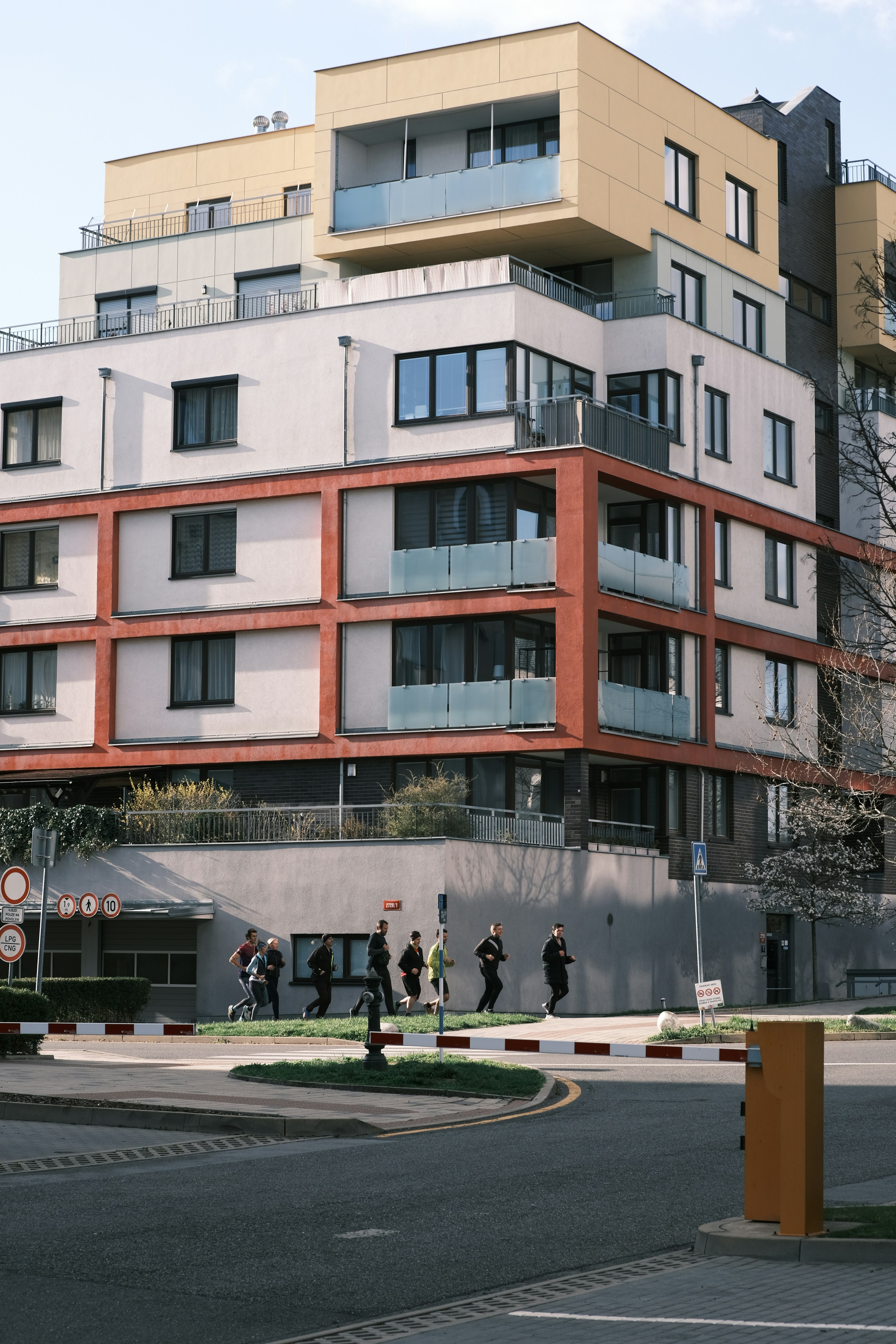 Terraced Modernism: Sunlit balconies crown a bustling urban courtyard