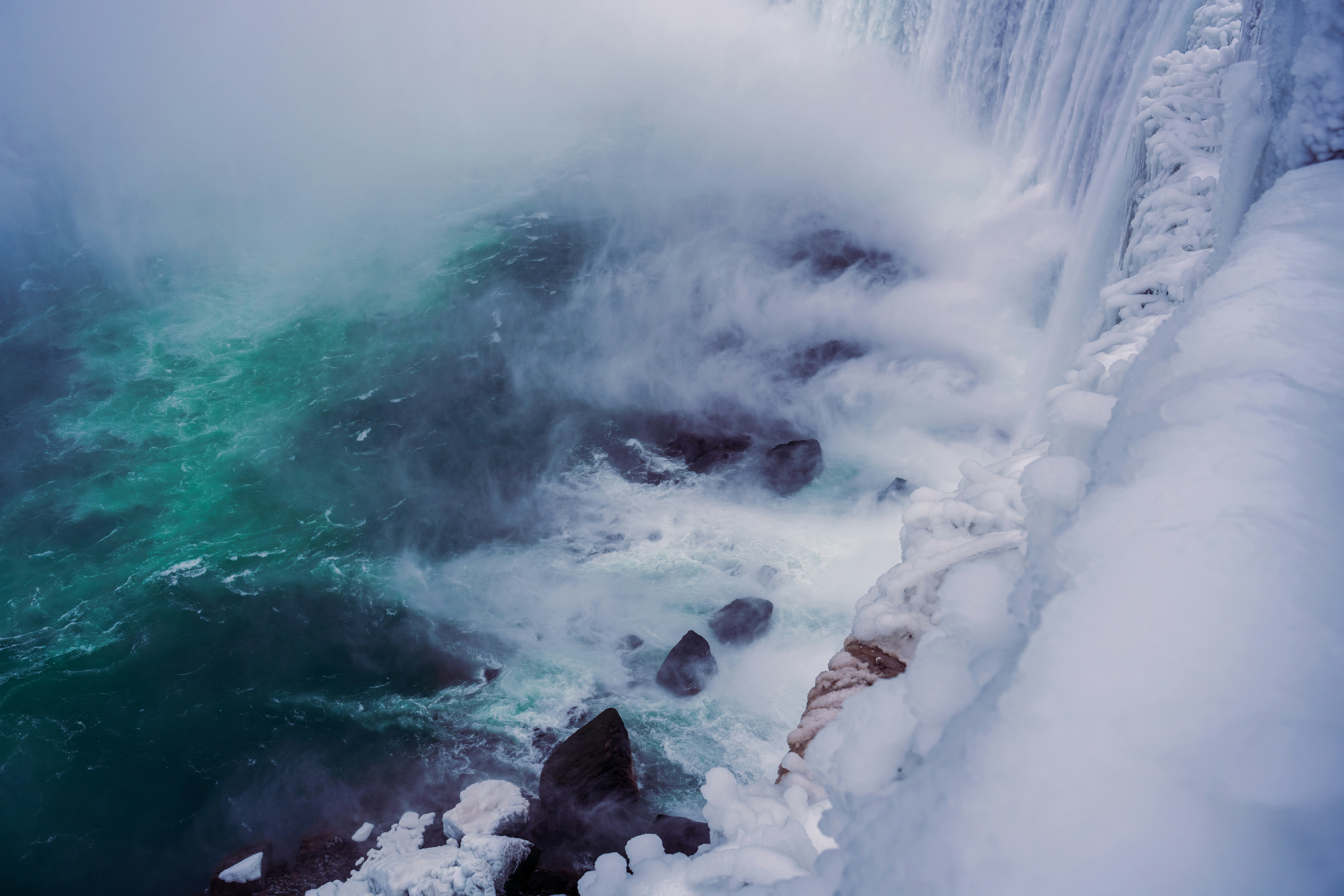 Water crashes at the base of a frozen waterfall. photo – Free Sea Image ...