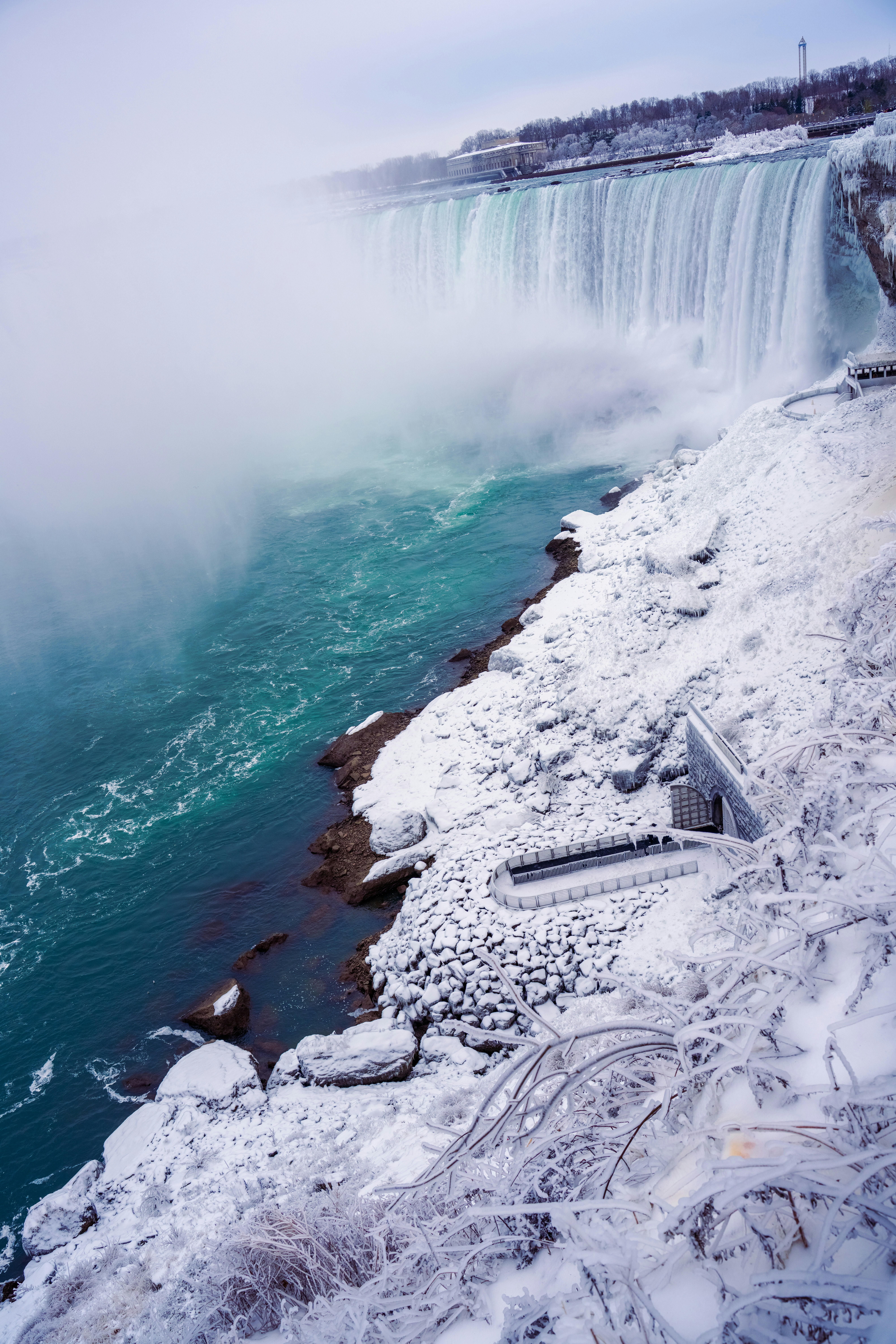 Icebound Curtain: Turquoise Wake Beneath the Mist