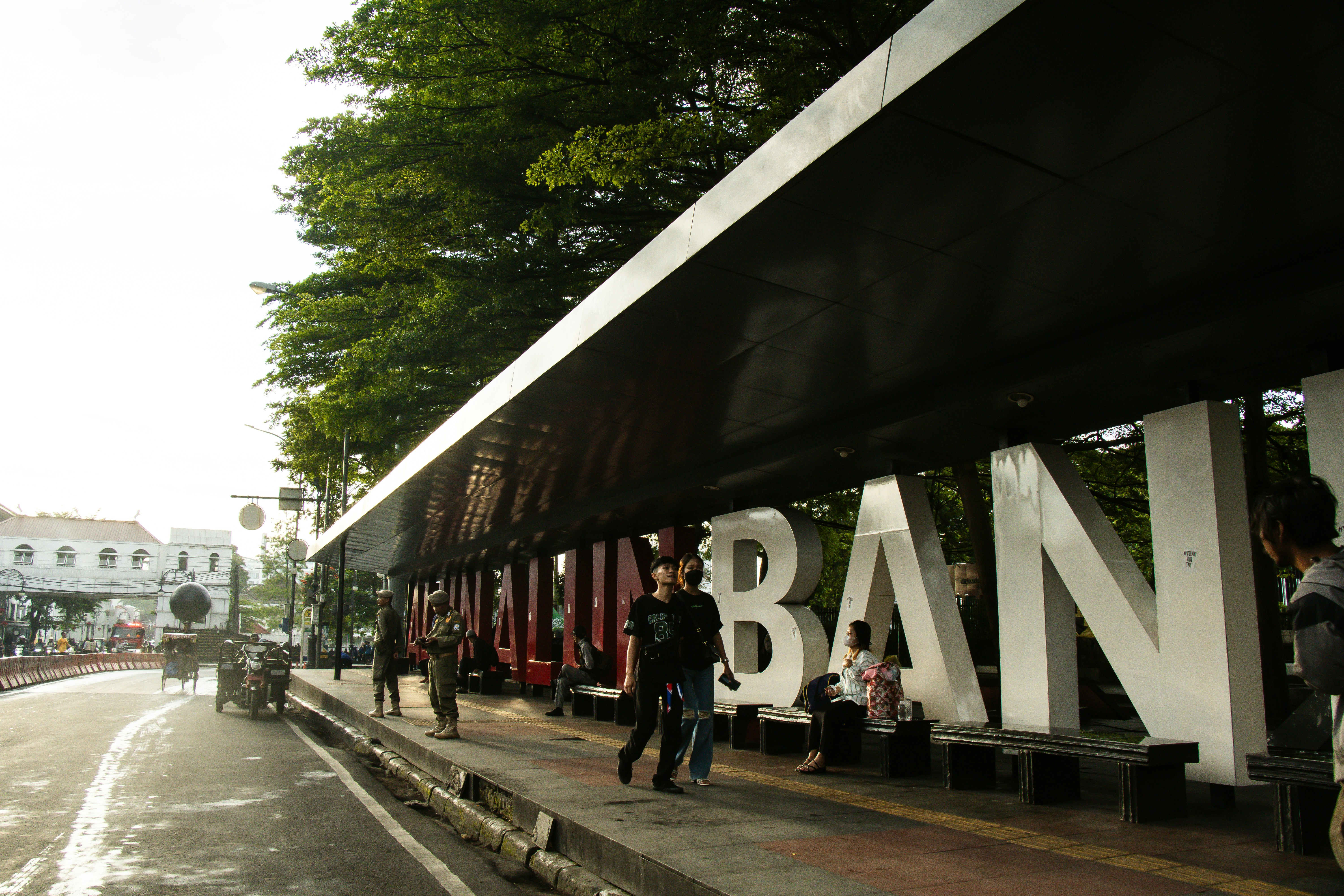 A city sign with people walking in front. photo – Free Building Image ...