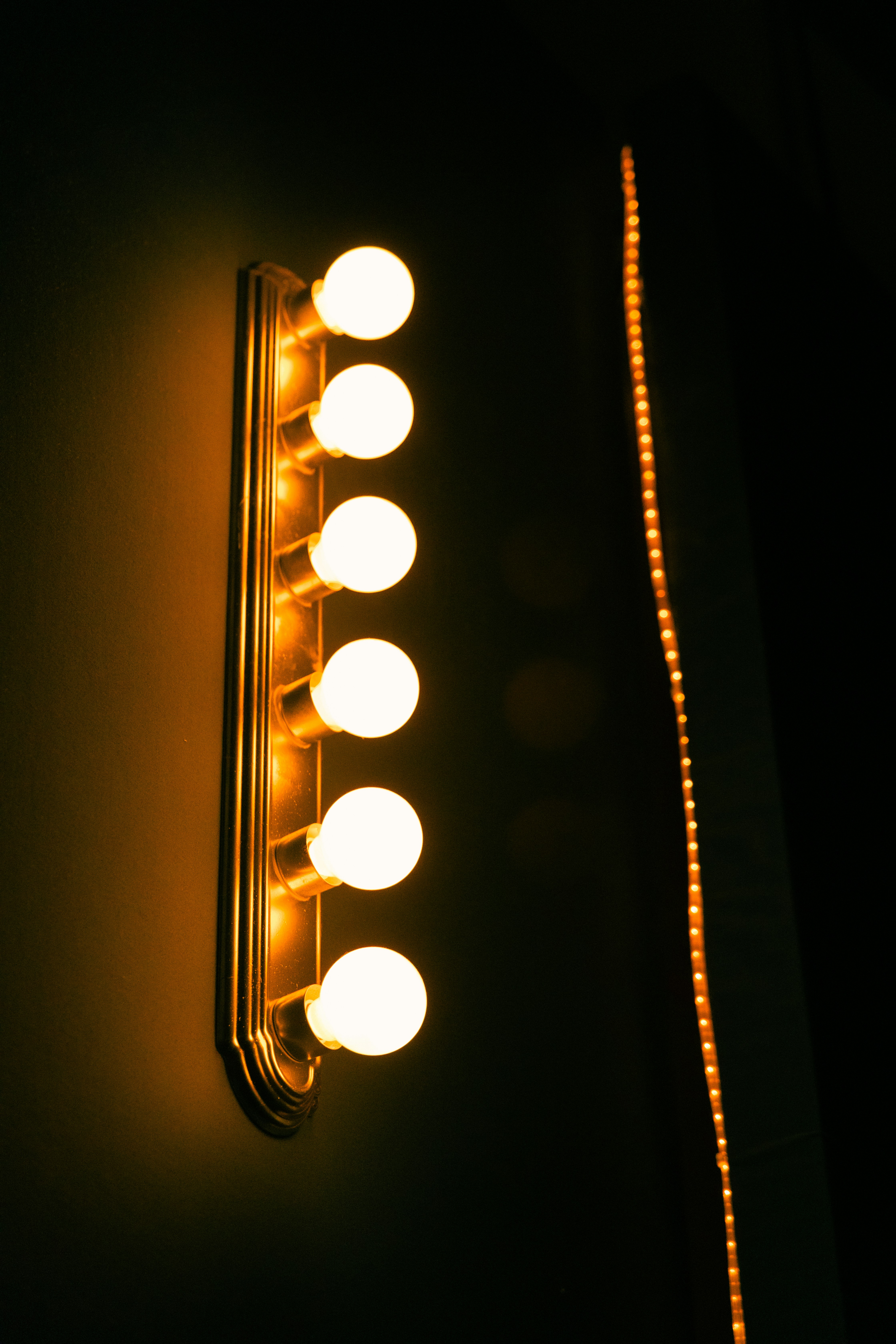 Glowing light bulbs illuminate a dark wall. photo – Free Light Image on ...