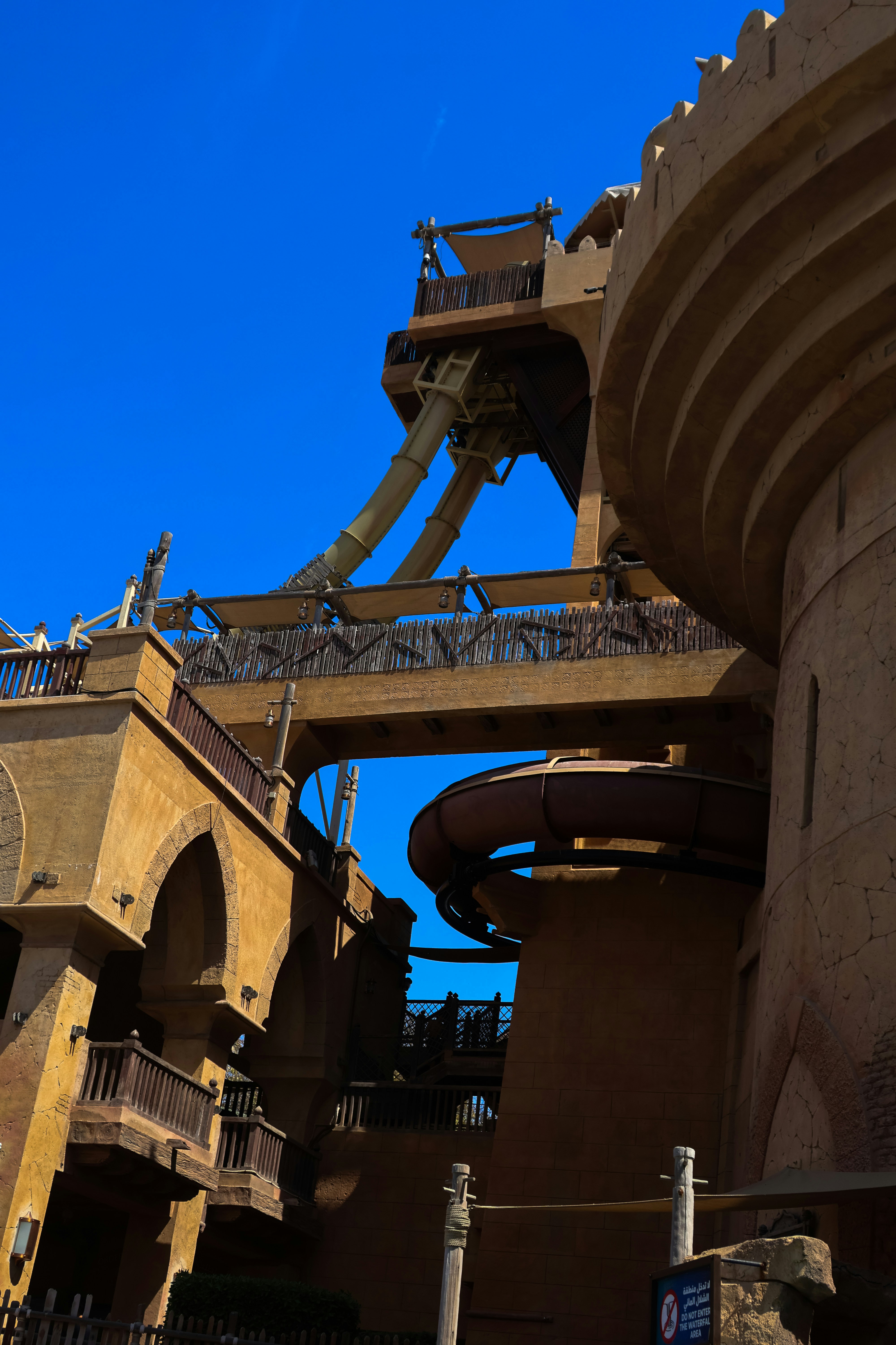 Industrial wonder: curving slide and arches against a blue sky