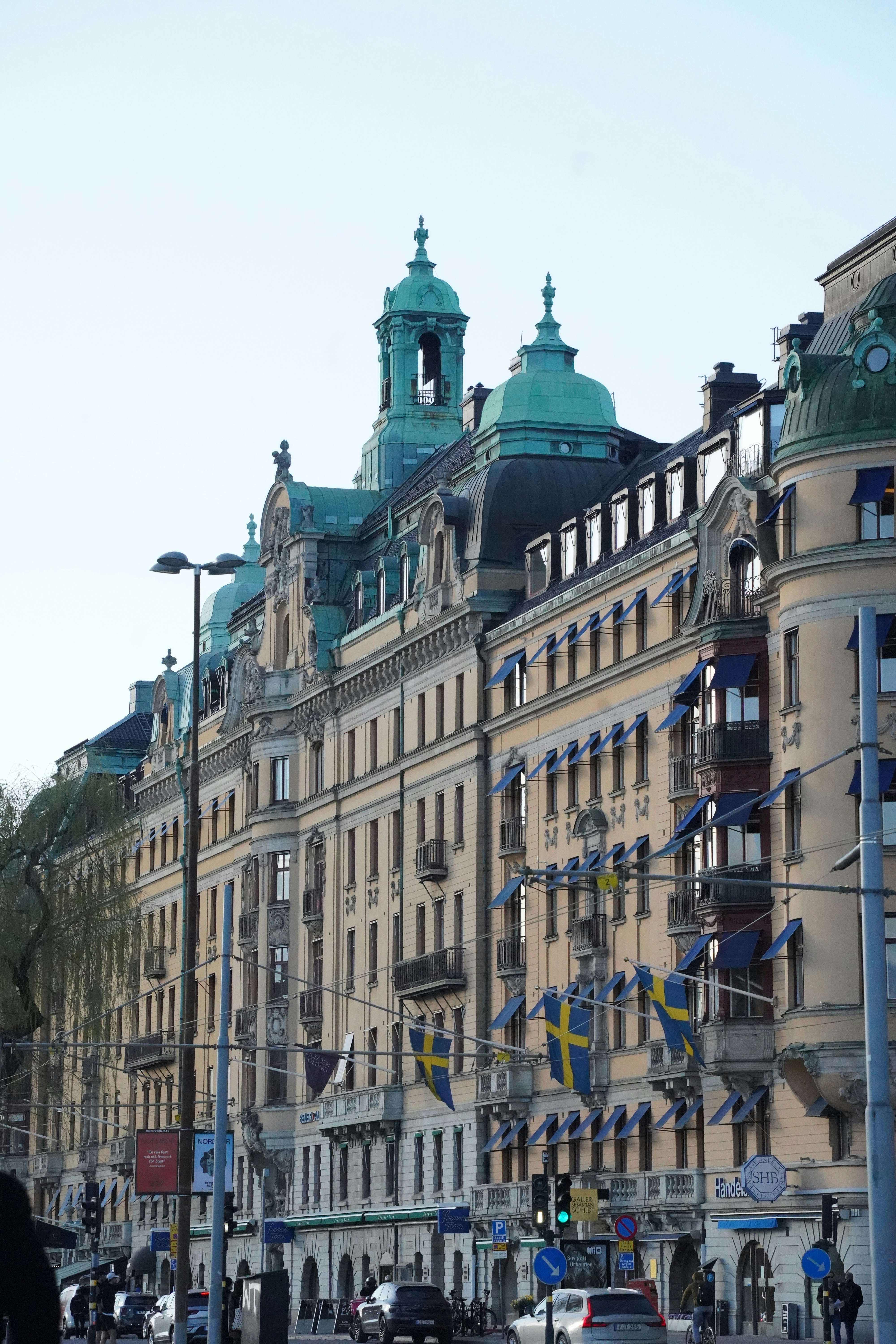 Nordic Flags and Turquoise Domes: A City Facade Along a Busy Street