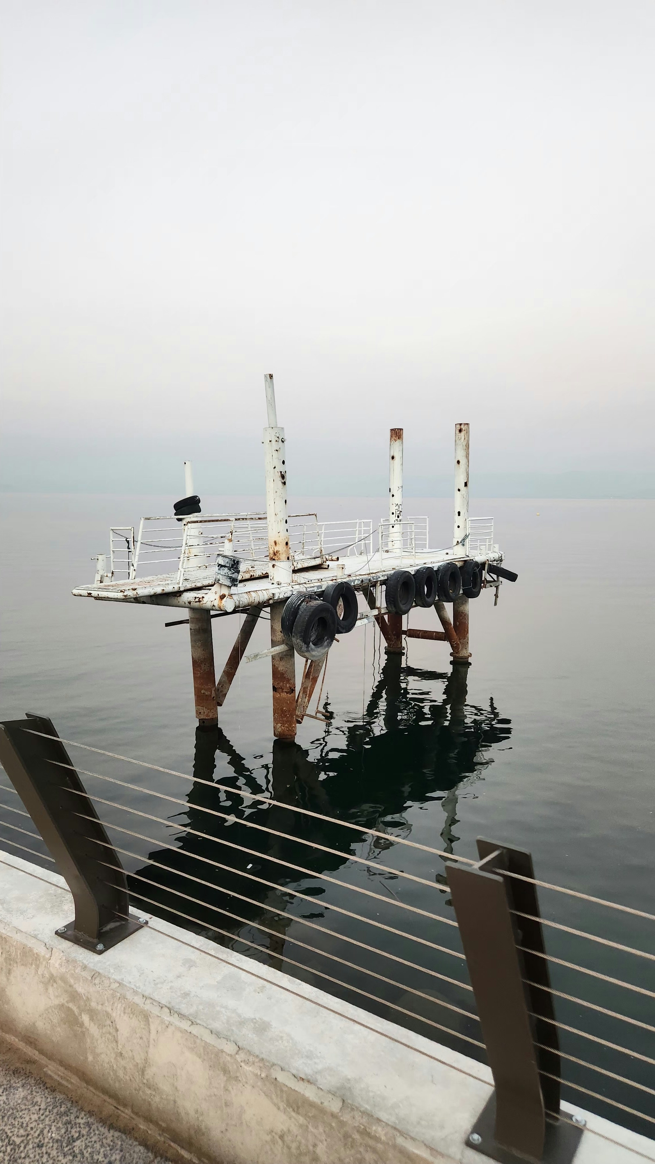 A weathered pier juts out into calm water. photo – Free Outdoors Image ...