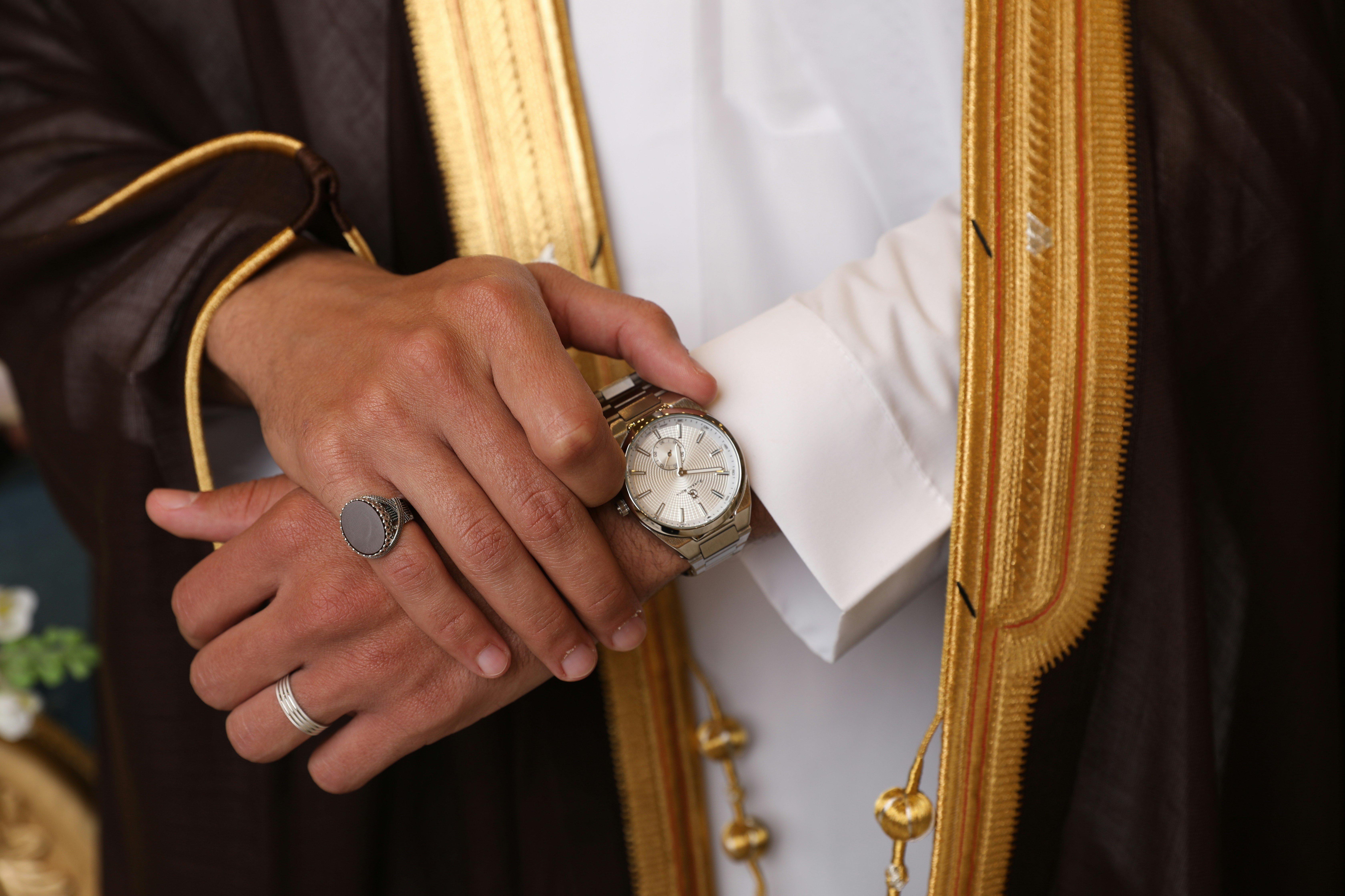 Hands of Ceremony: A Regal Timepiece and Ring Adorn a Symbolic Moment