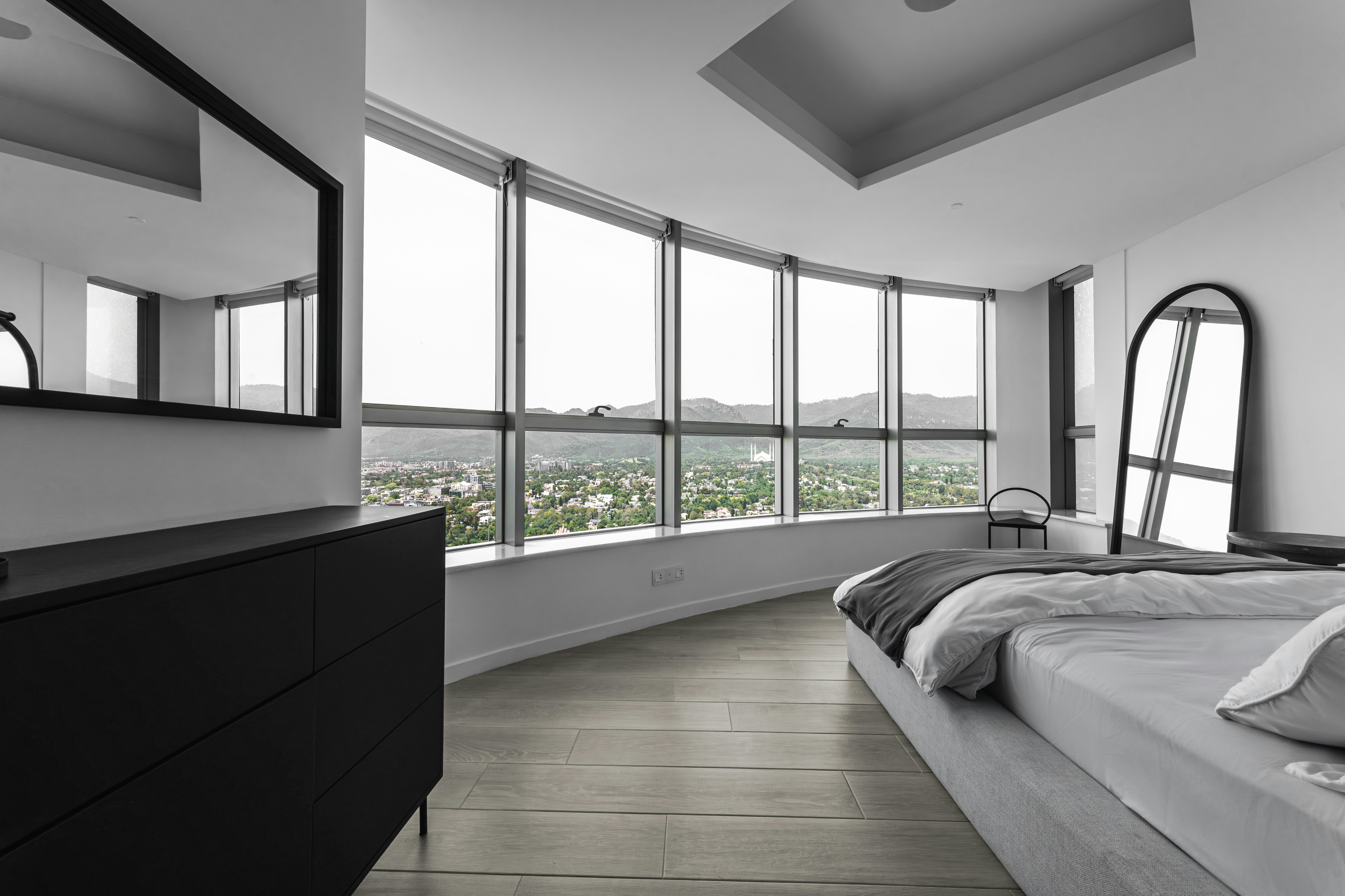 A modern bedroom with large curved windows. photo – Free Interior ...