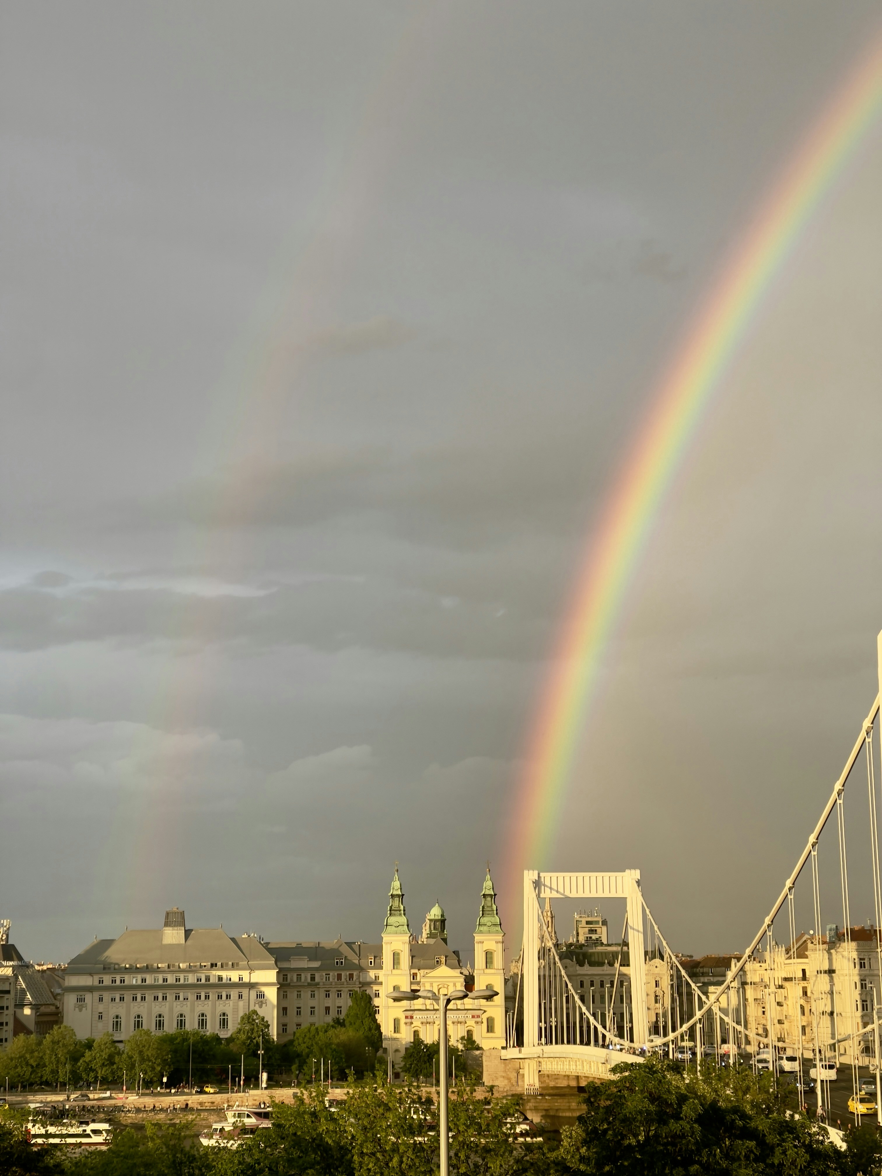 Twin Rainbows Over the Riverfront Bridge at Golden Hour