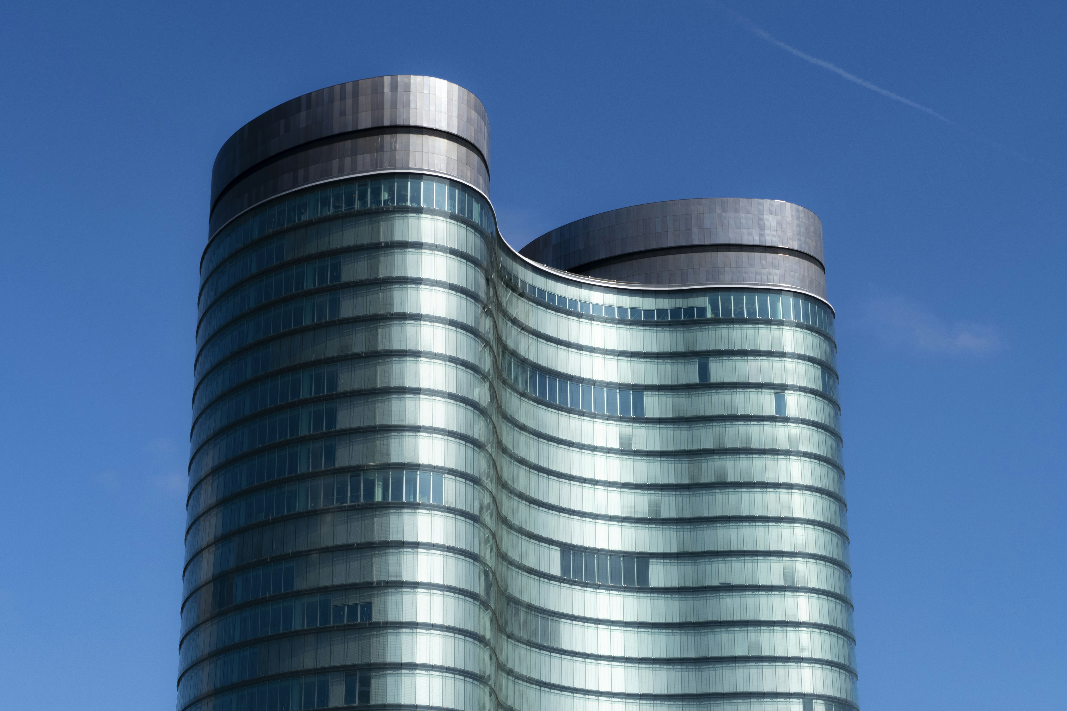 Modern curved skyscraper against a blue sky. photo – Free Office Image ...