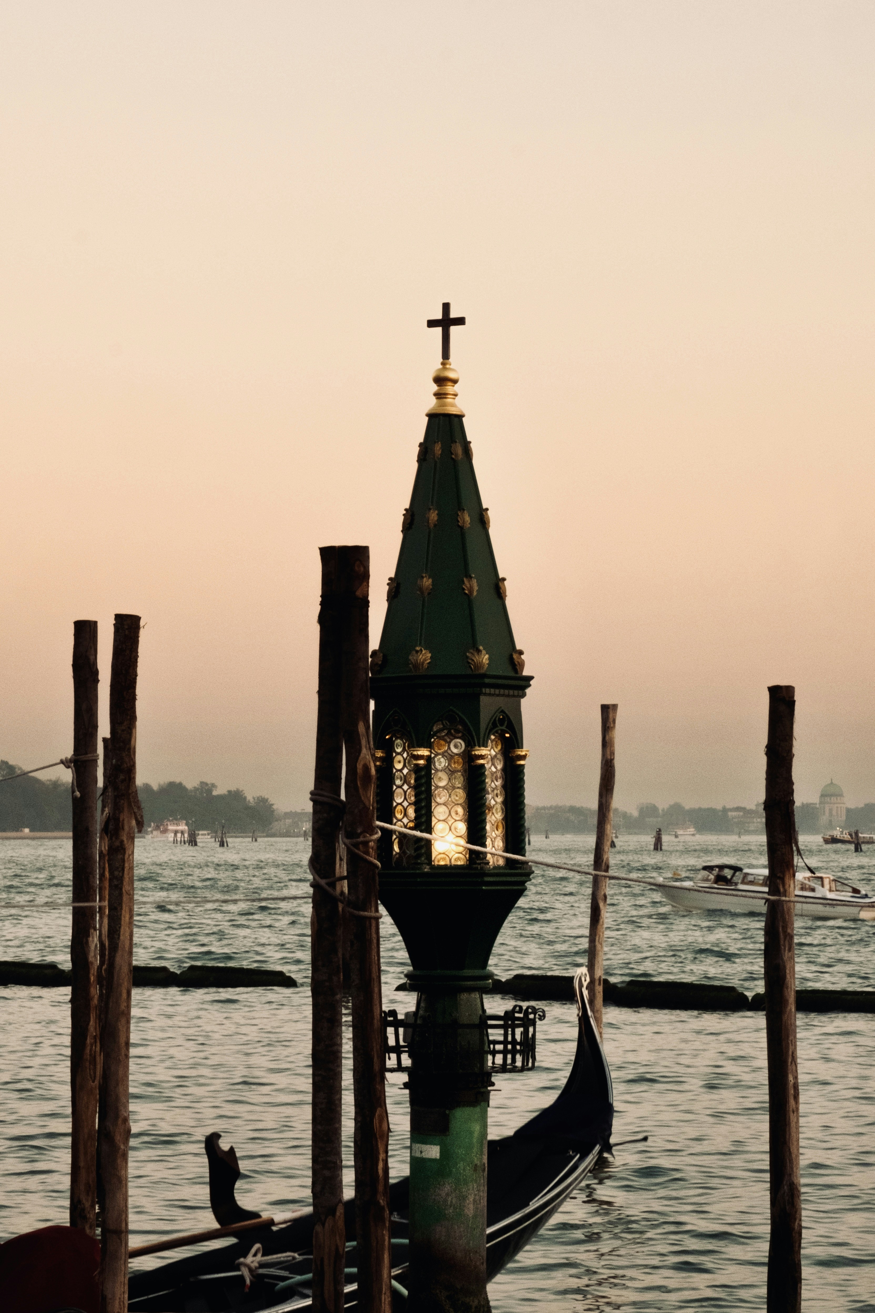 Cross-Topped Lantern Rising Over Venetian Water at Sunset