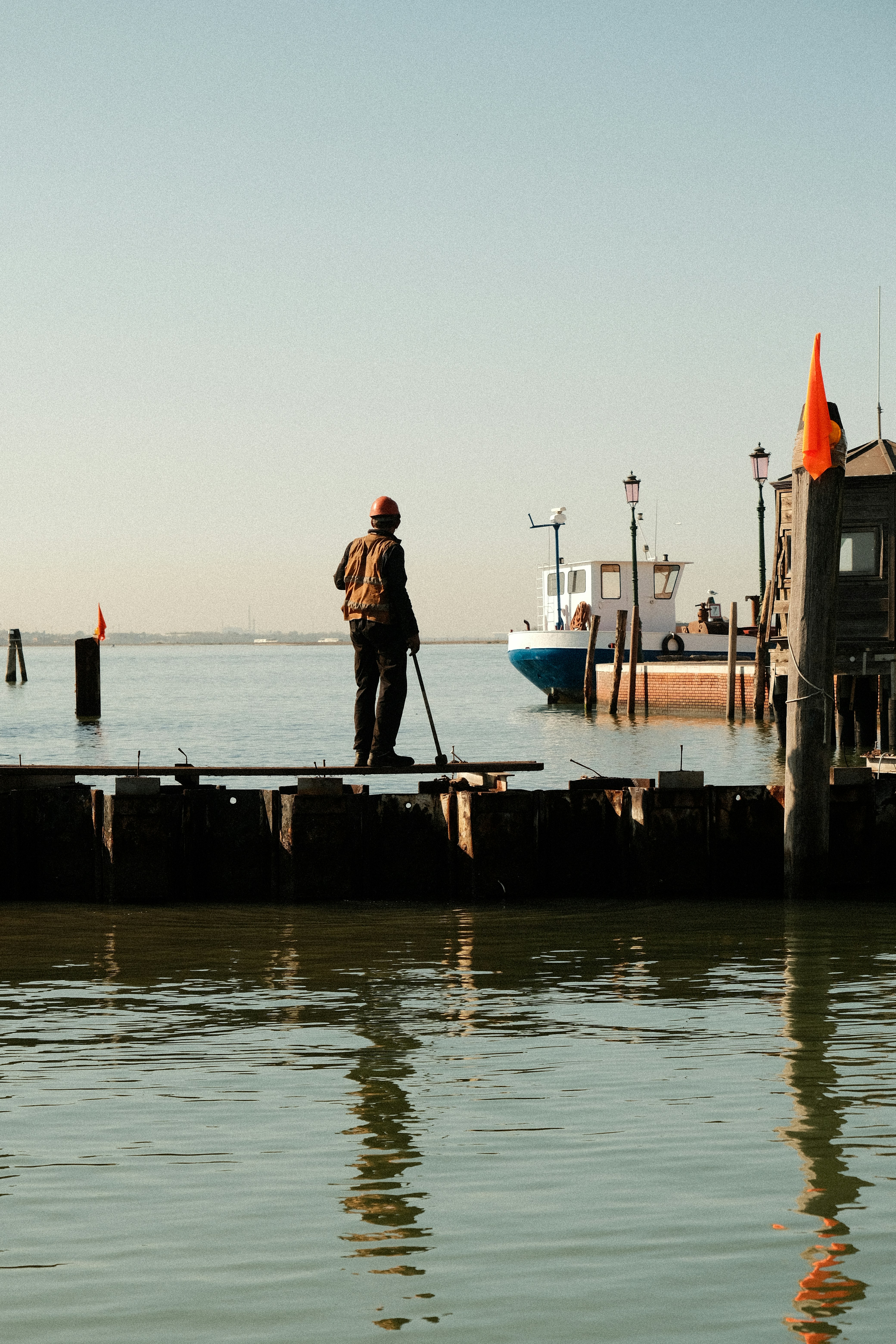 Pier Sentinel at Dusk Harbor: A Fisherman's Quiet Moment