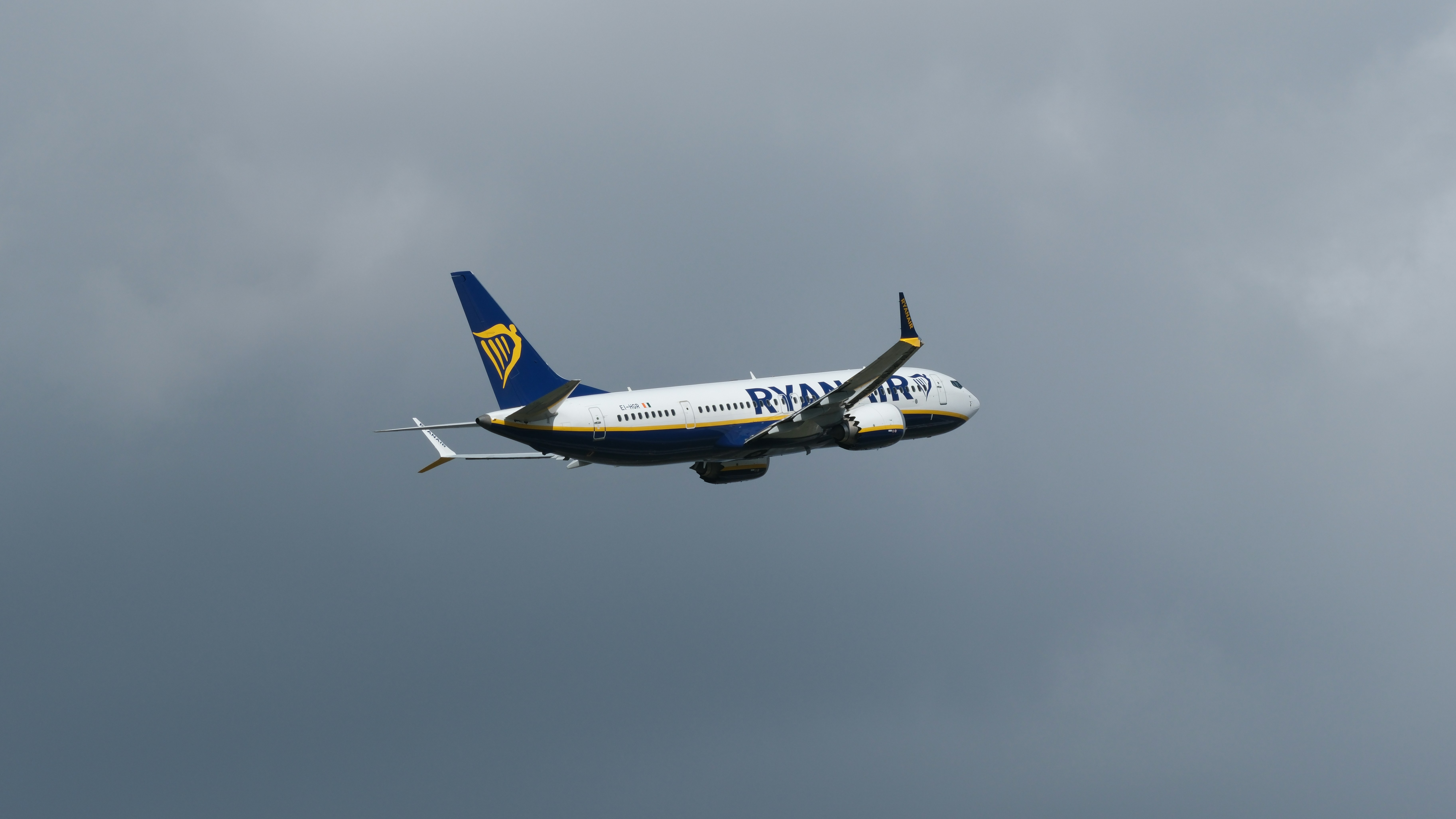 Ryanair - B737 Max 8 - EI-HGR | A ryanair airplane flies through cloudy skies.