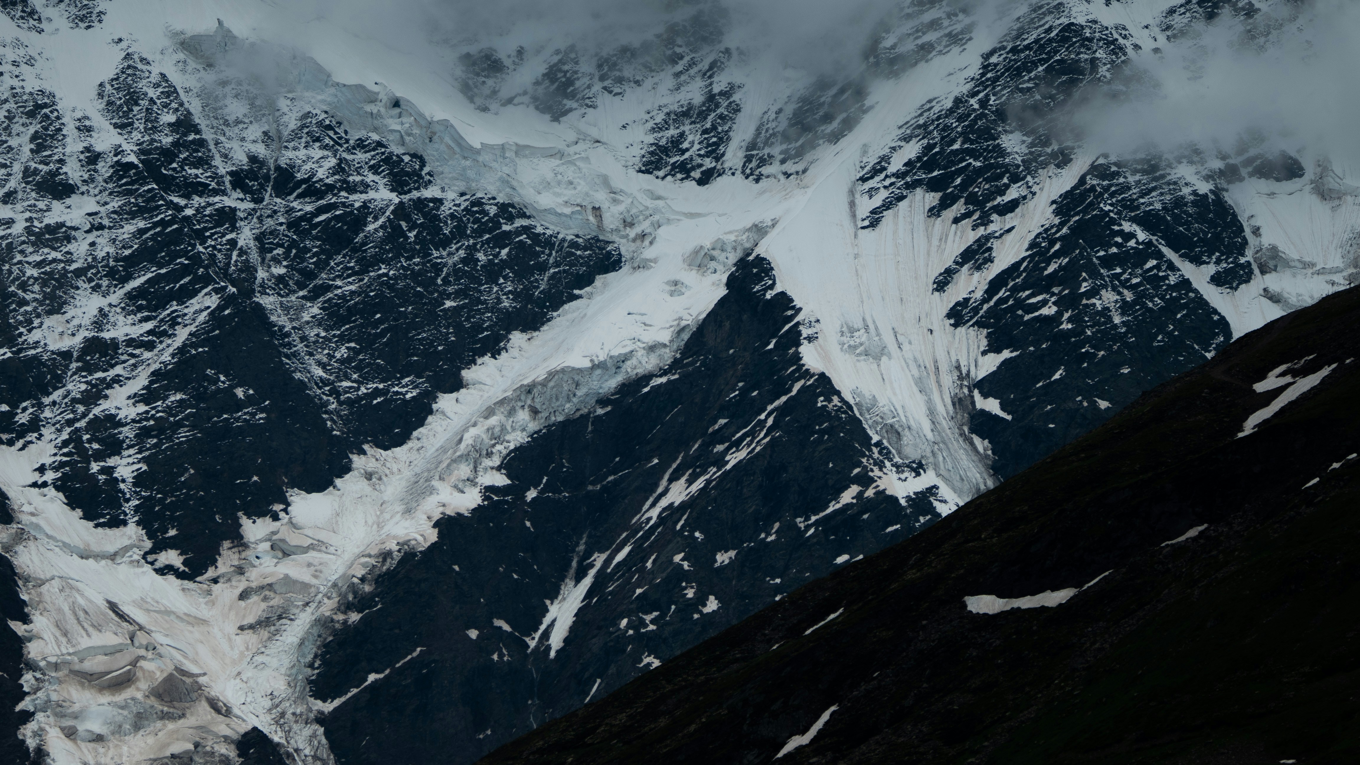 Glaciated Summit Slope Carved by Snow and Shadow