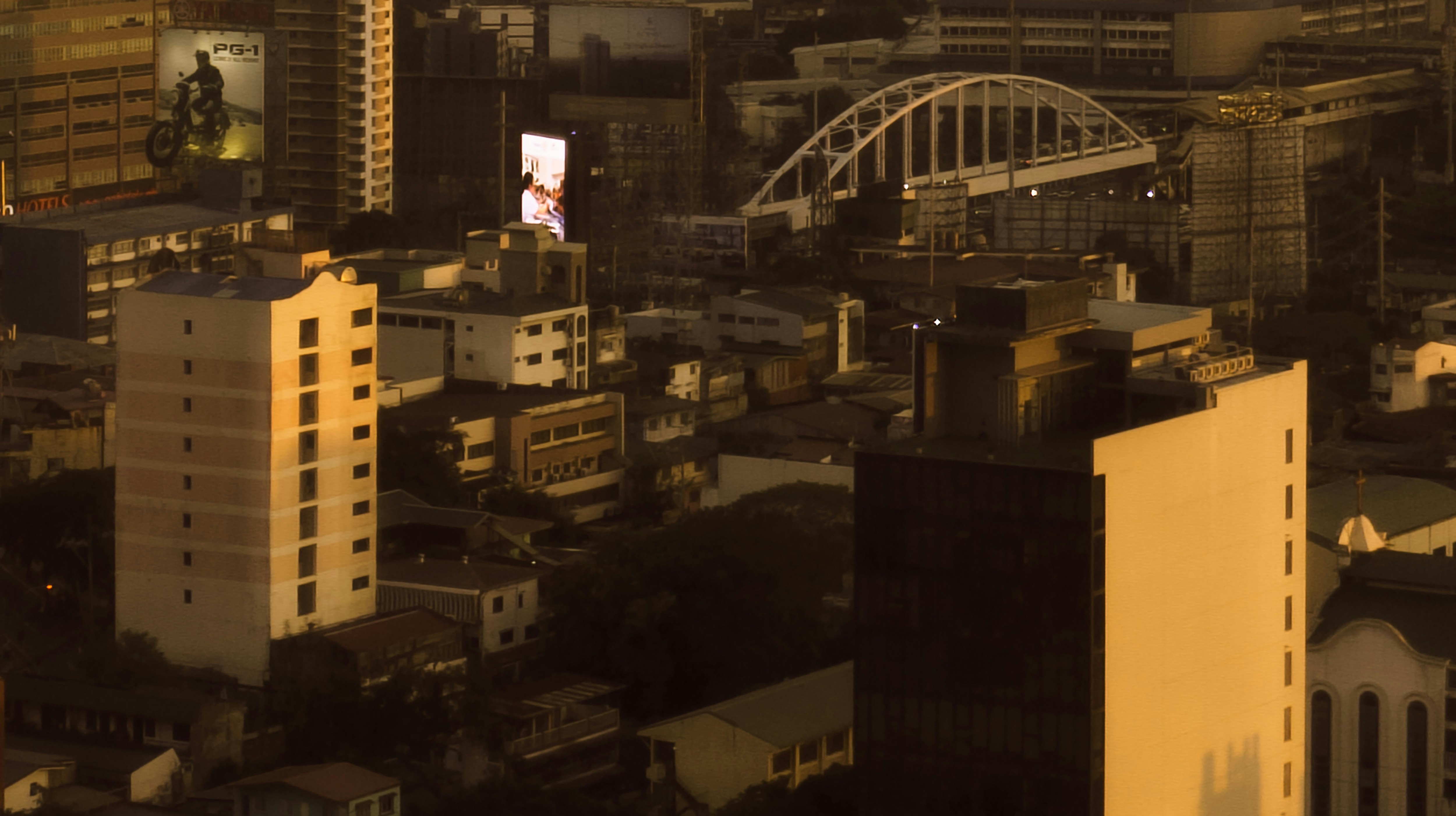 Cityscape at twilight with lit buildings.