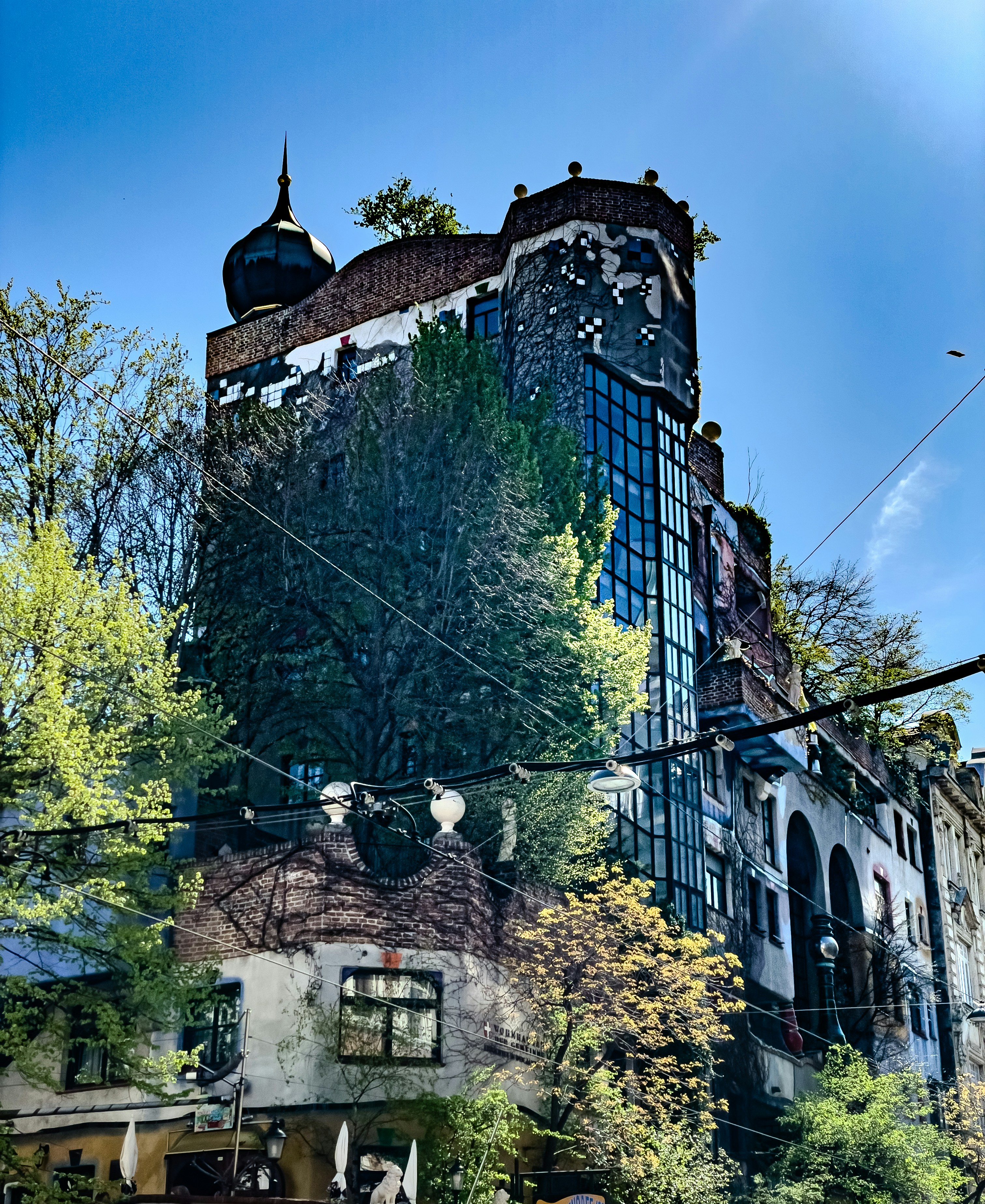Canopy Over Mosaic: A Modernist Tower Reaching Through the Trees