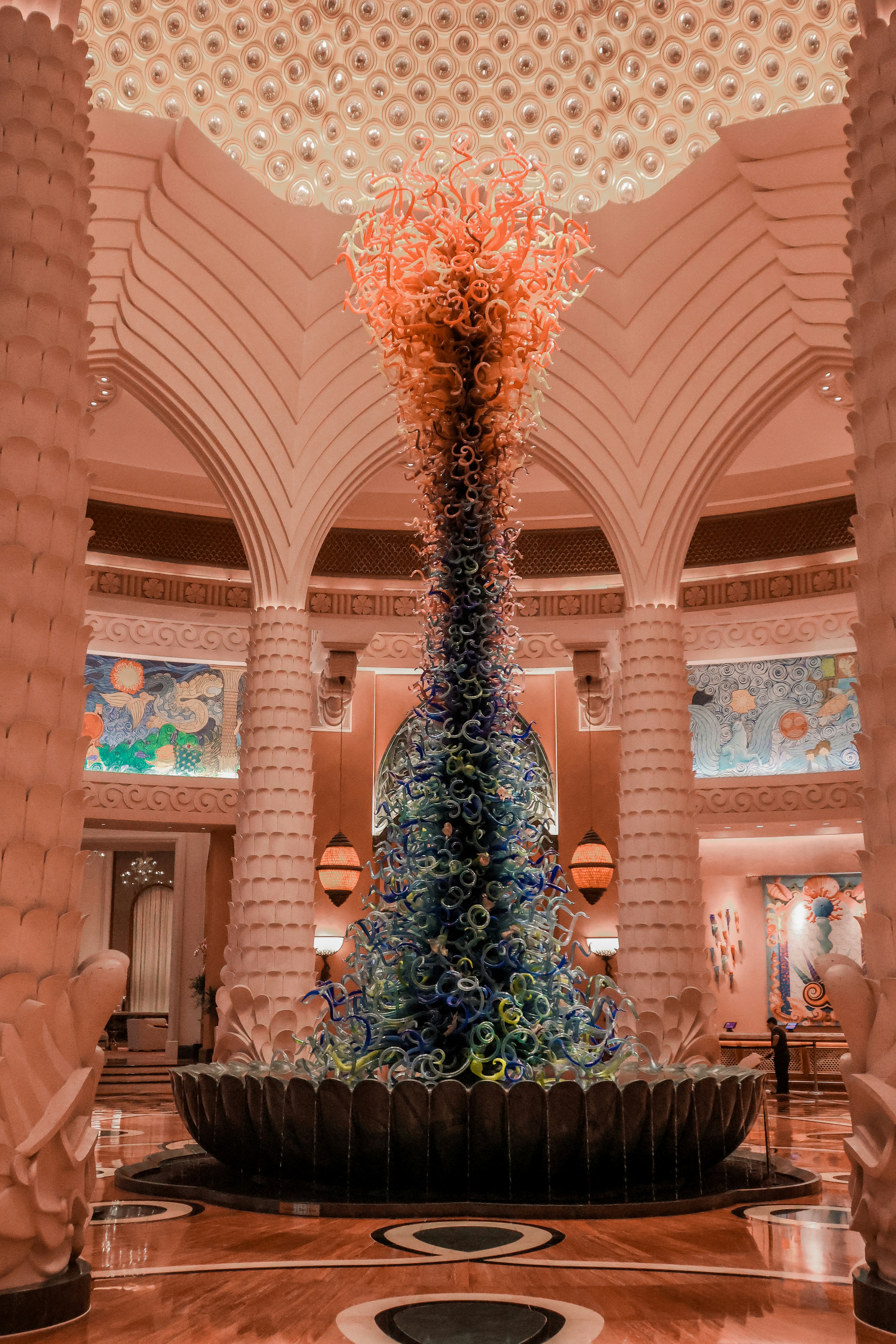A tall glass sculpture adorns an elegant lobby.