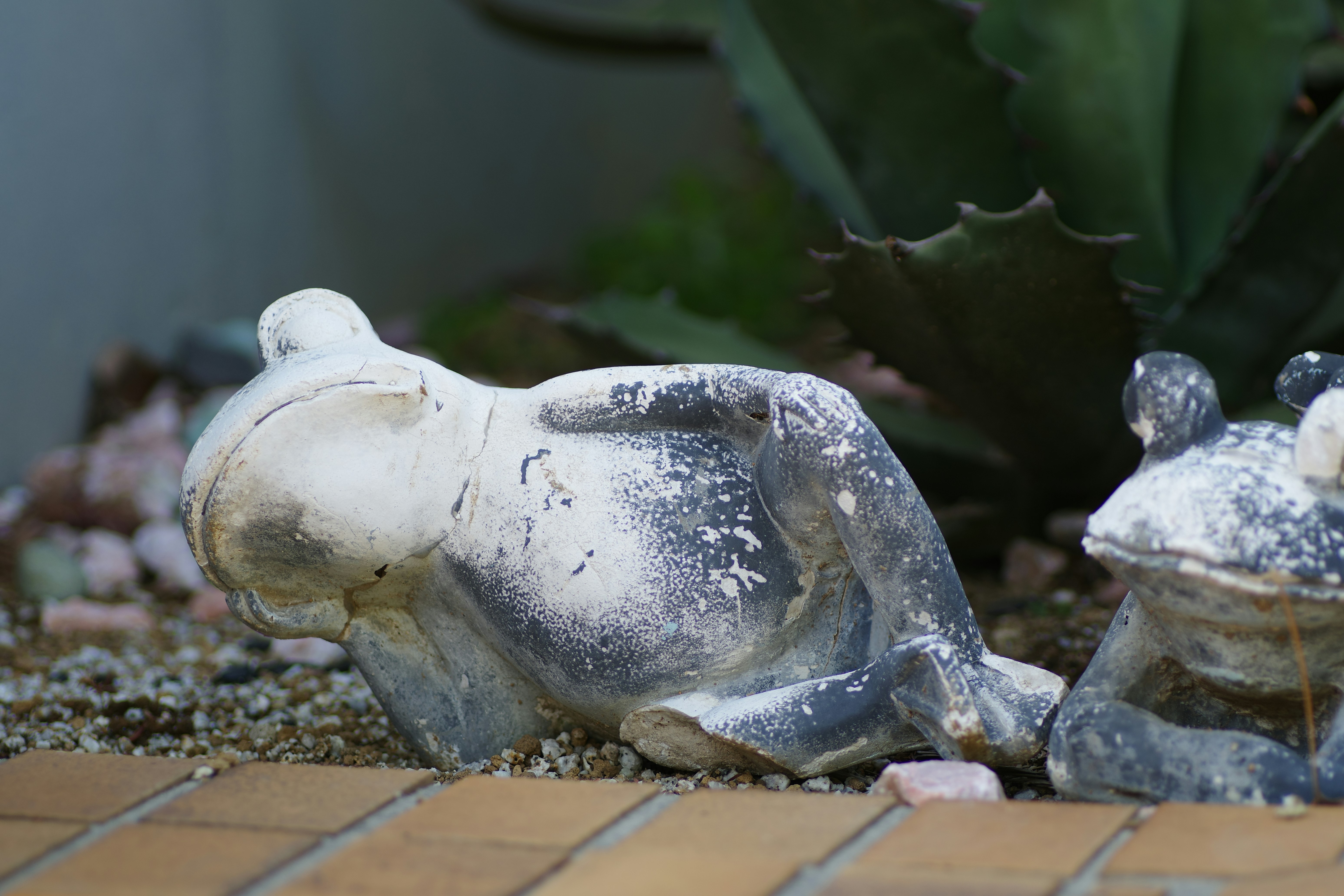 Weathered garden statues in soft focus foreground