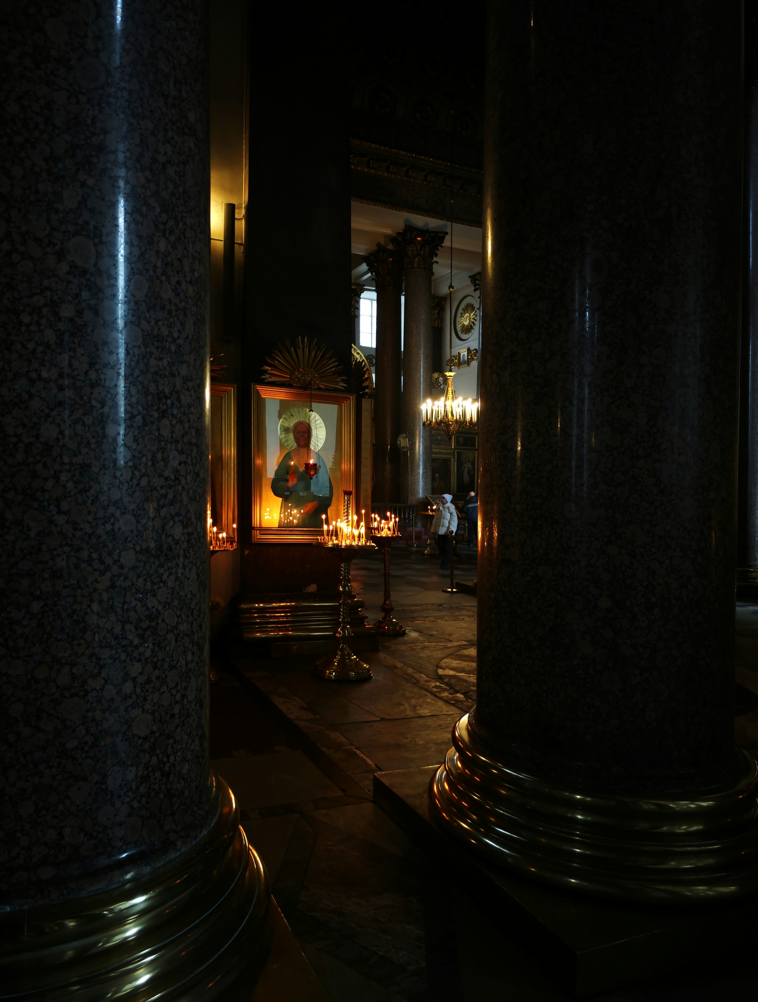 Inside a church, an icon glows with light.