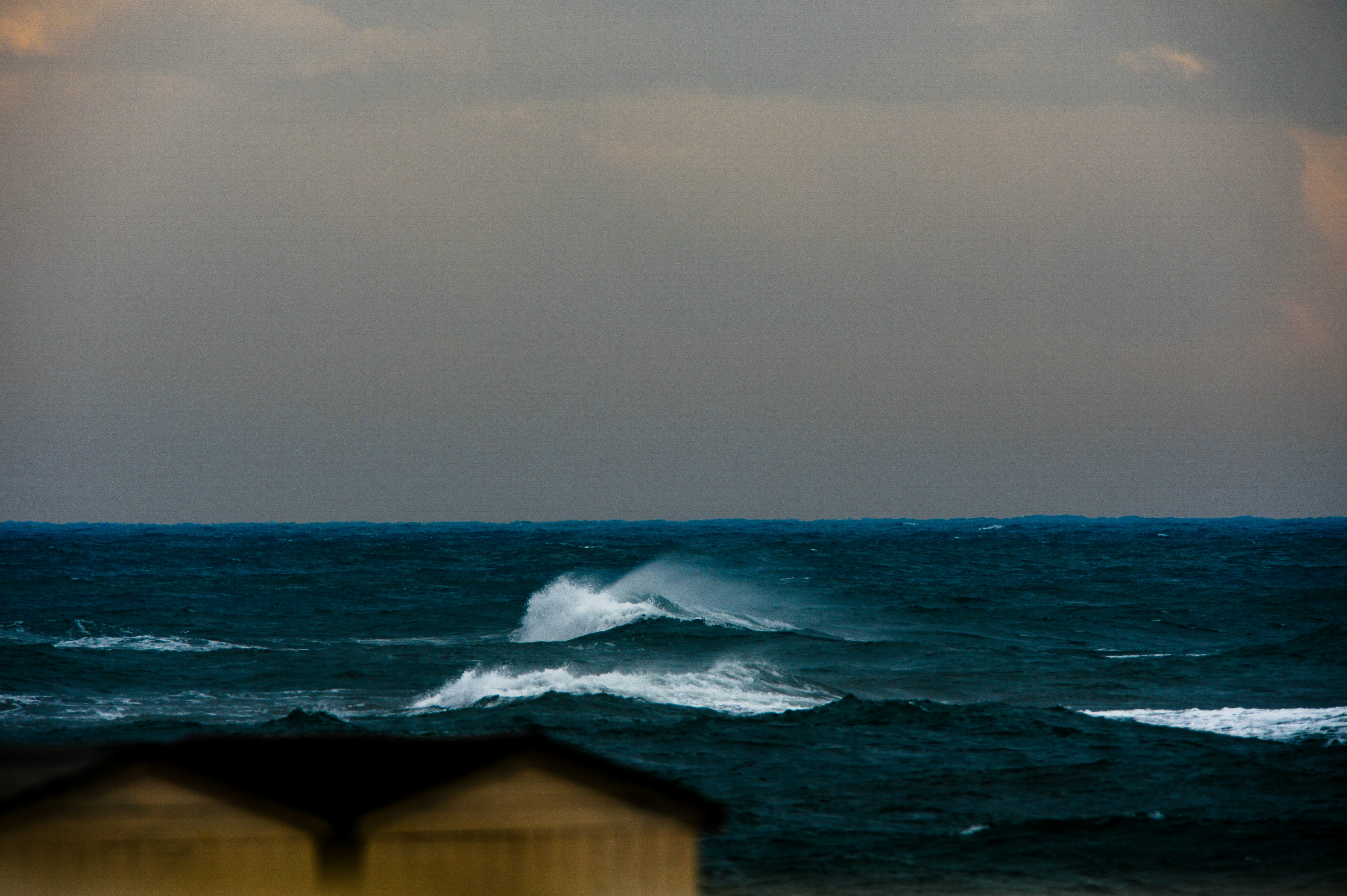 Rough ocean waves churn beneath a gray sky. photo – Free Sea Image on ...