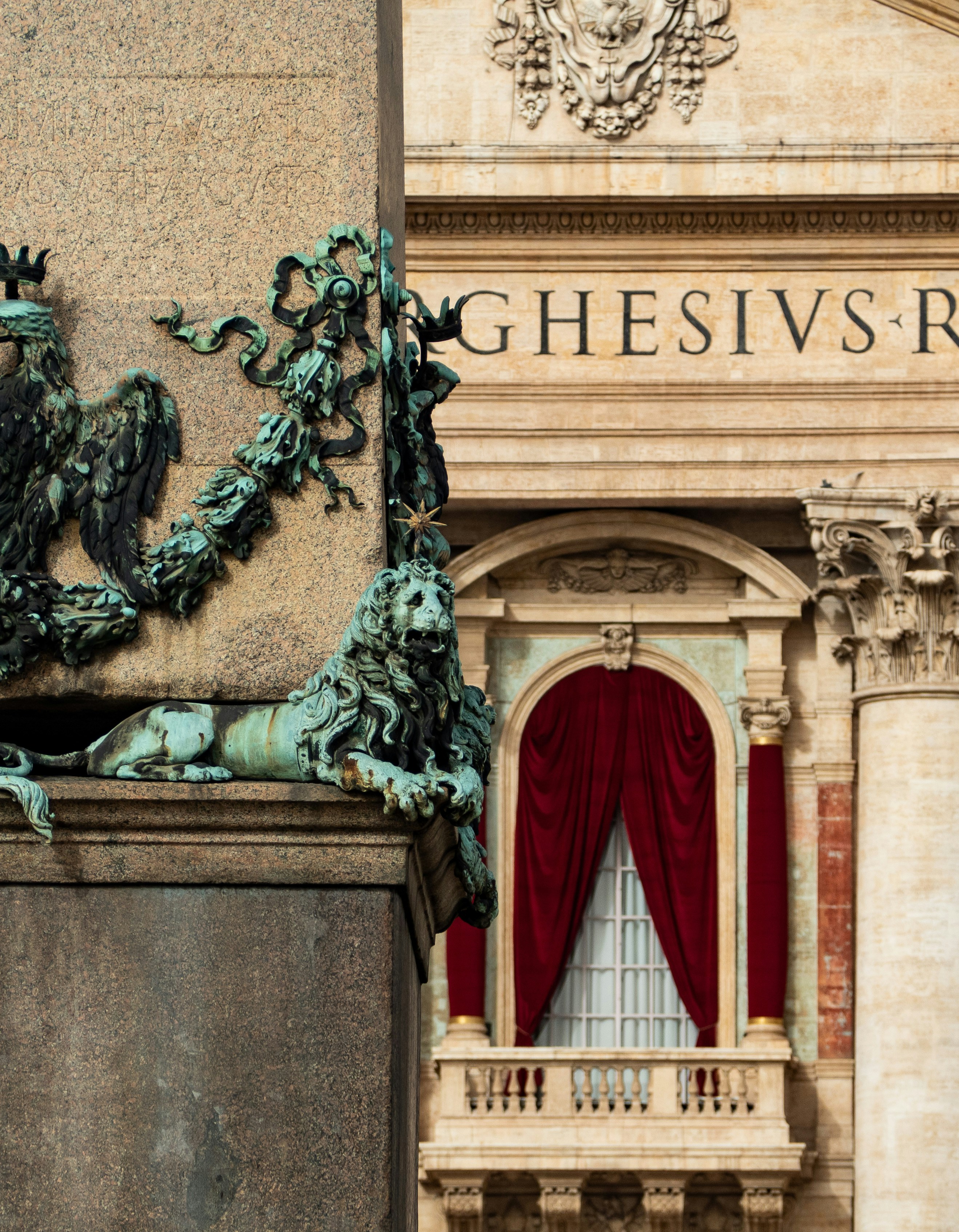 Stone Monument and Baroque Curtain: A Tale of Sculpted Detail and Red Velvet Arch