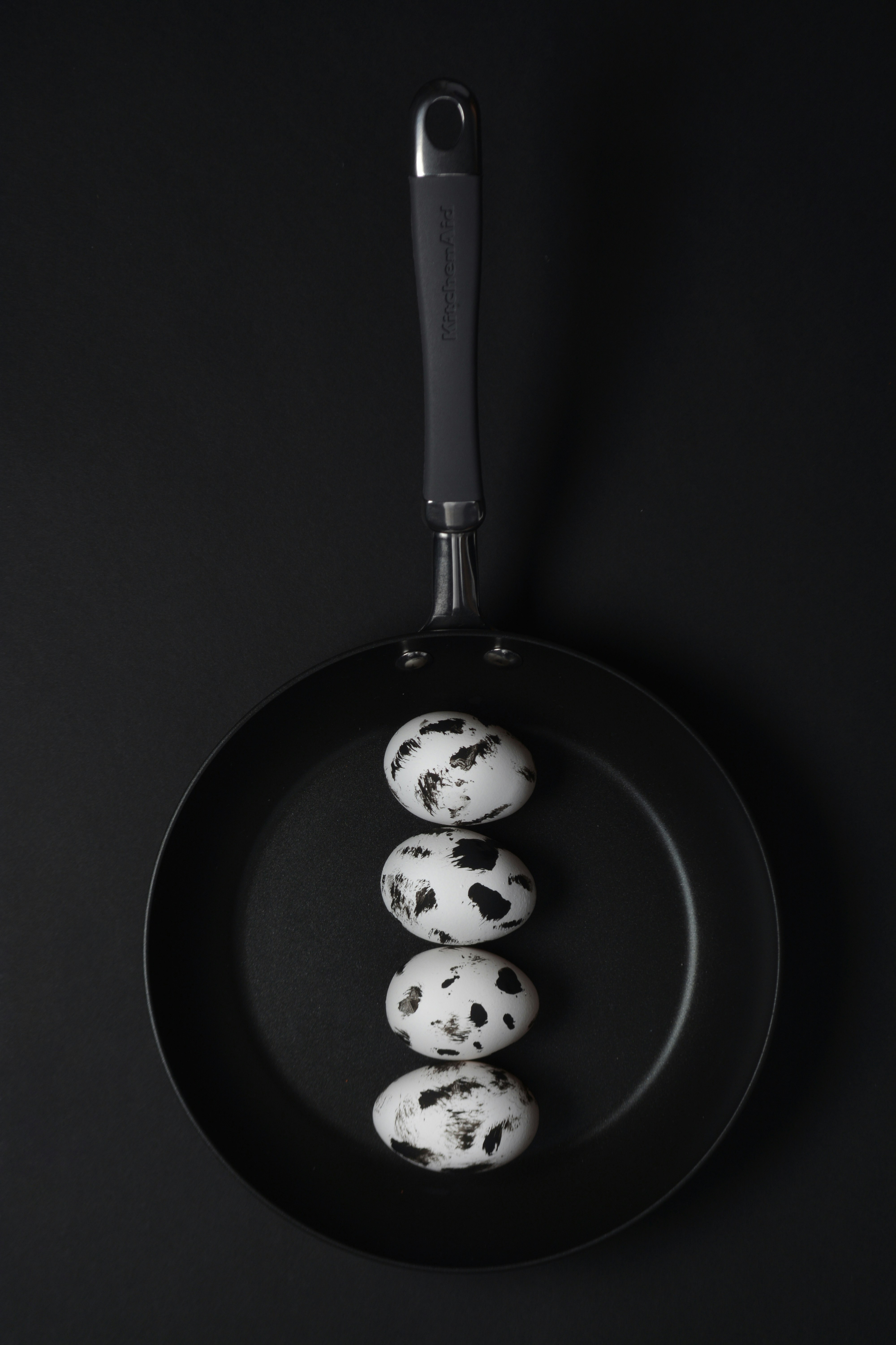 Midnight Stack: Four Speckled Eggs in a Matte Skillet