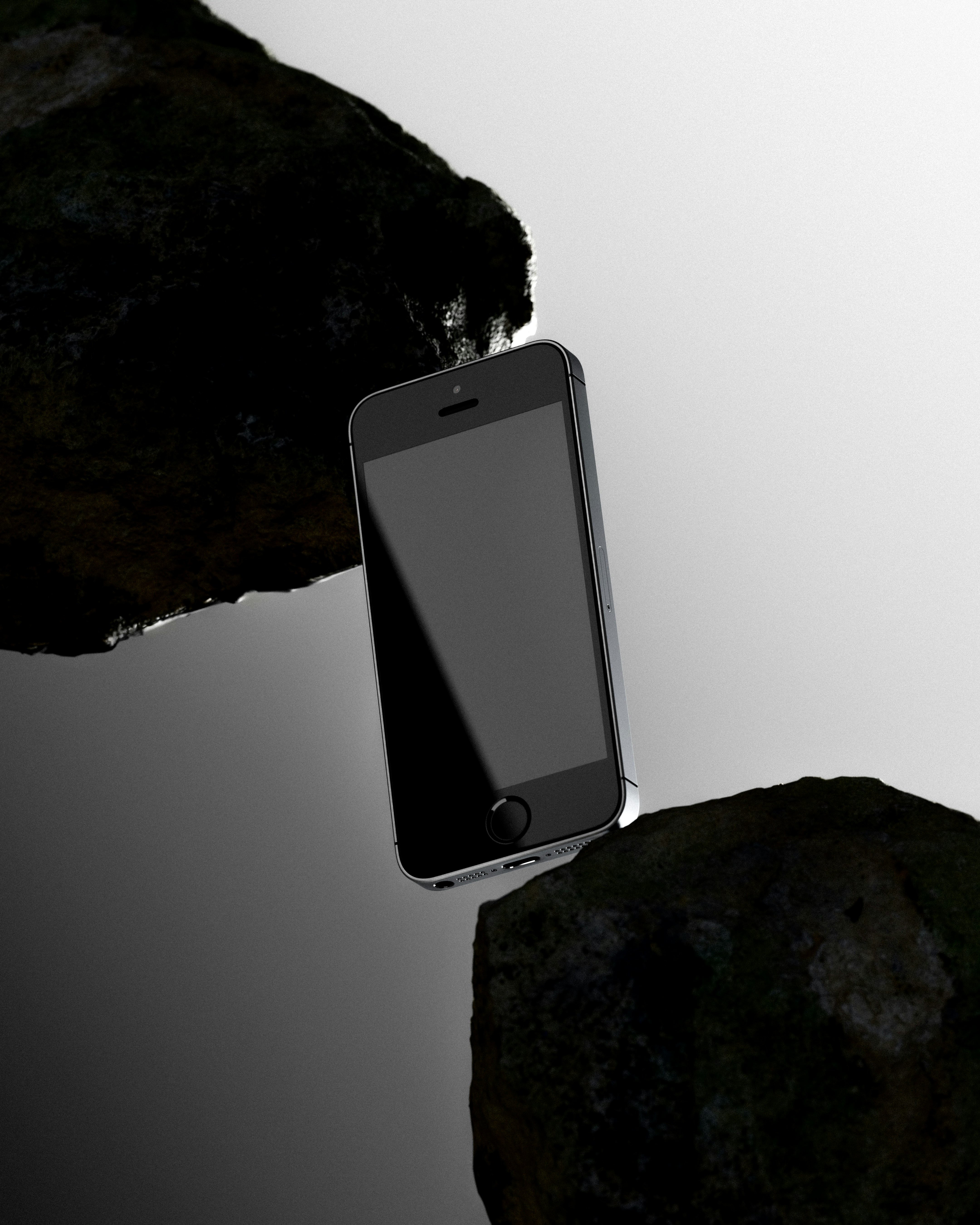 Smartphone suspended precariously between two rocks. photo – Free ...