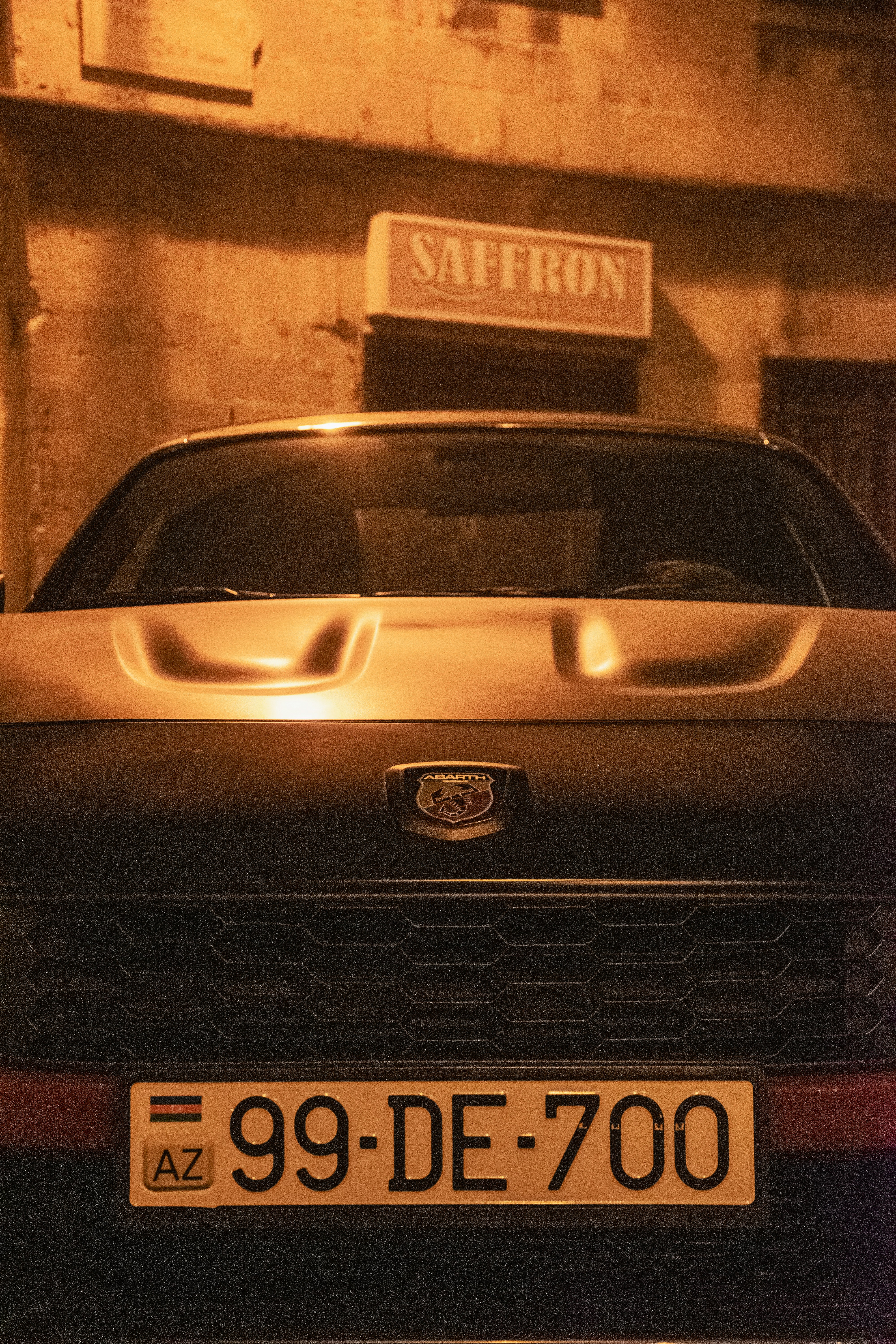 A car is parked in front of the saffron sign. photo – Free Car Image on ...