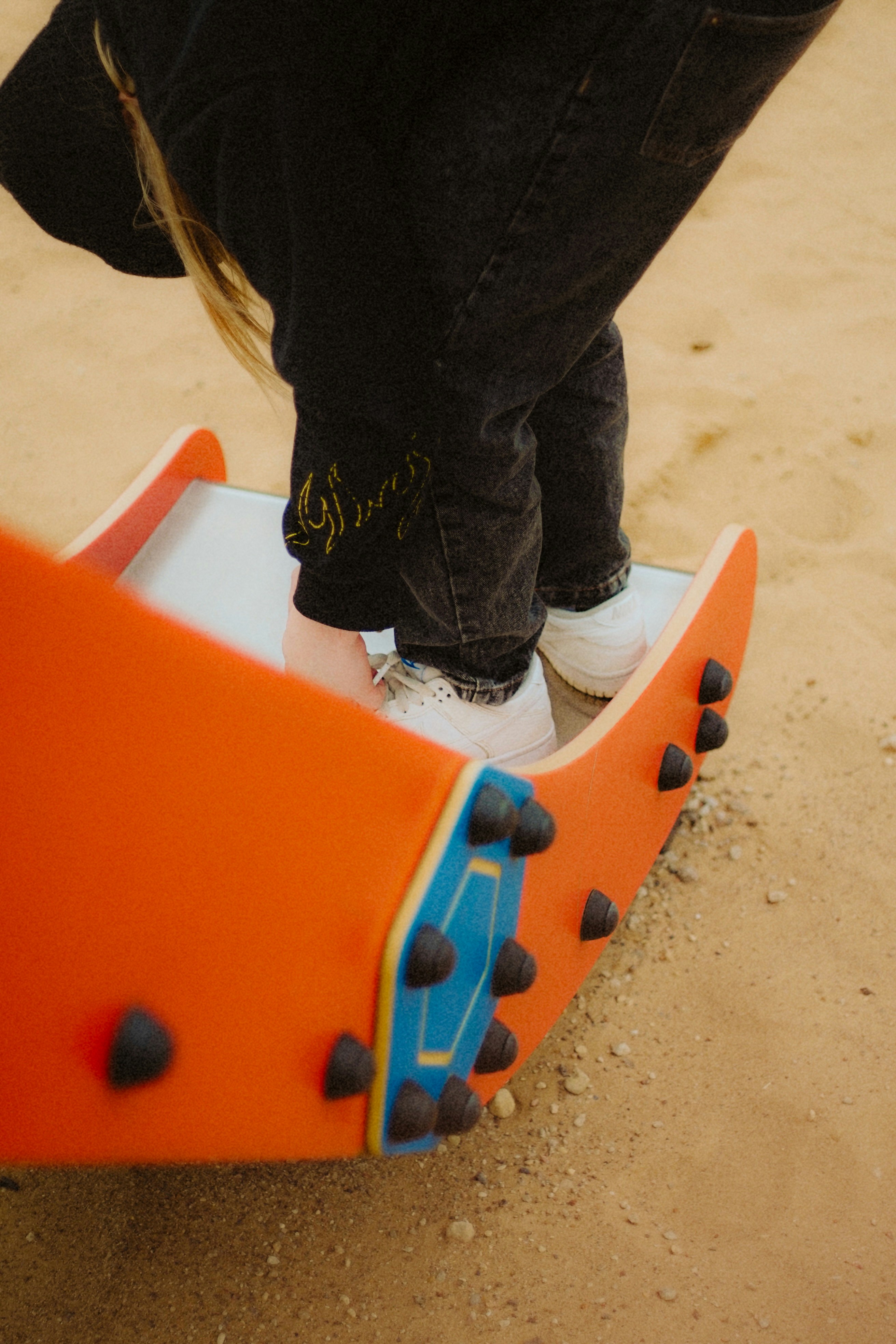 A child slides down a colorful playground slide. photo – Free Human ...