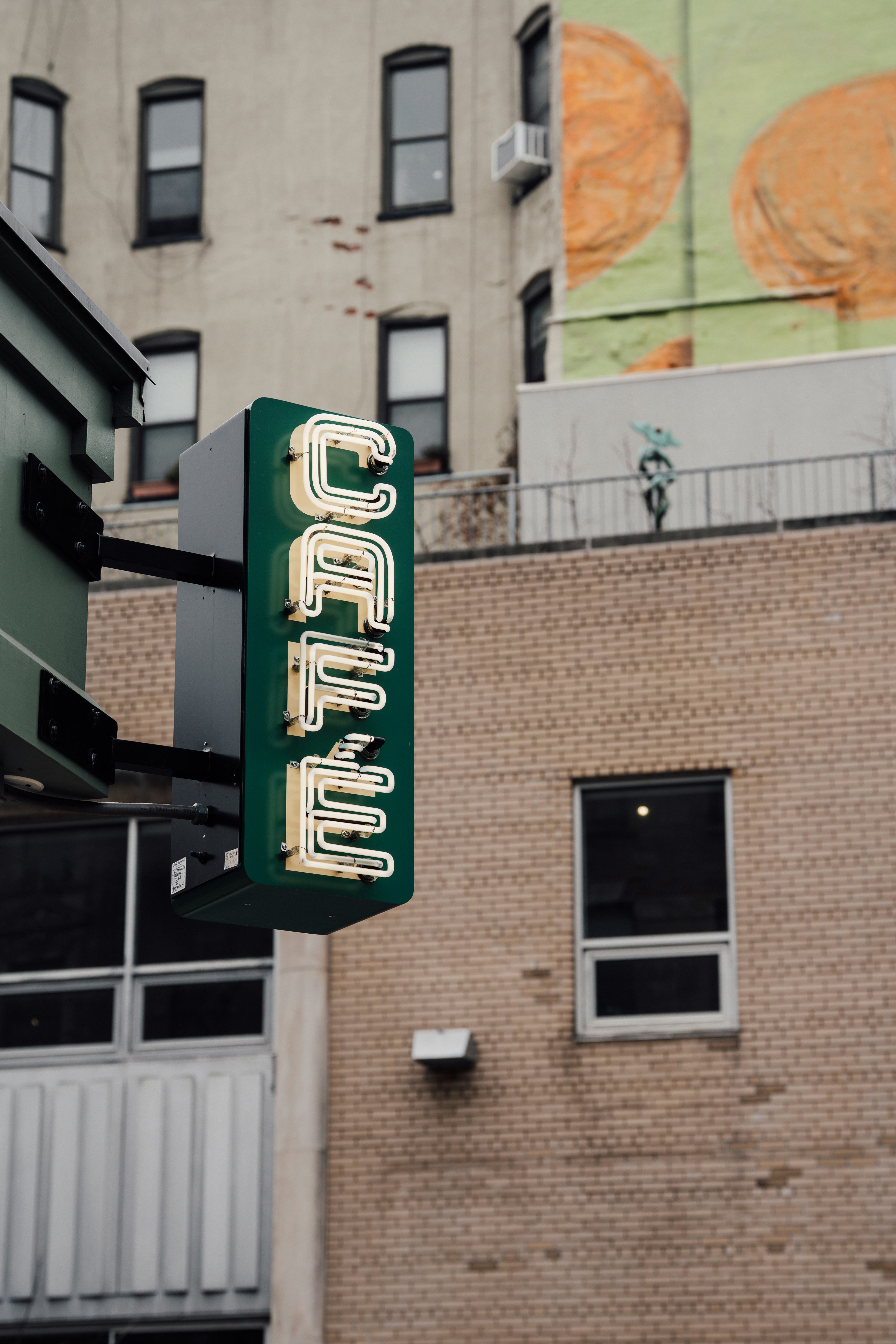 Vertical Neon Sign in an Urban Corner
