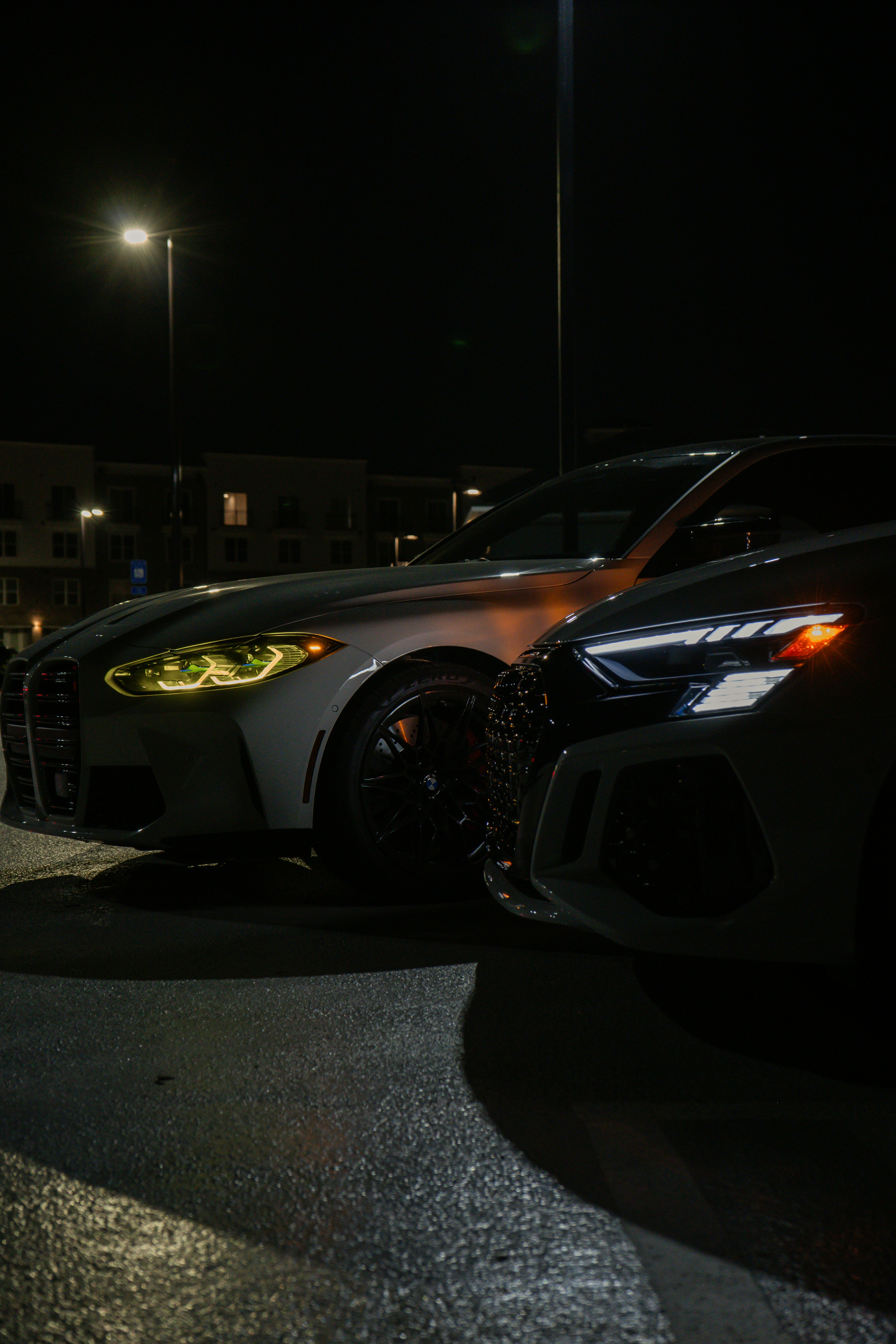 Two luxury cars are parked outside at night. photo – Free Car Image on ...