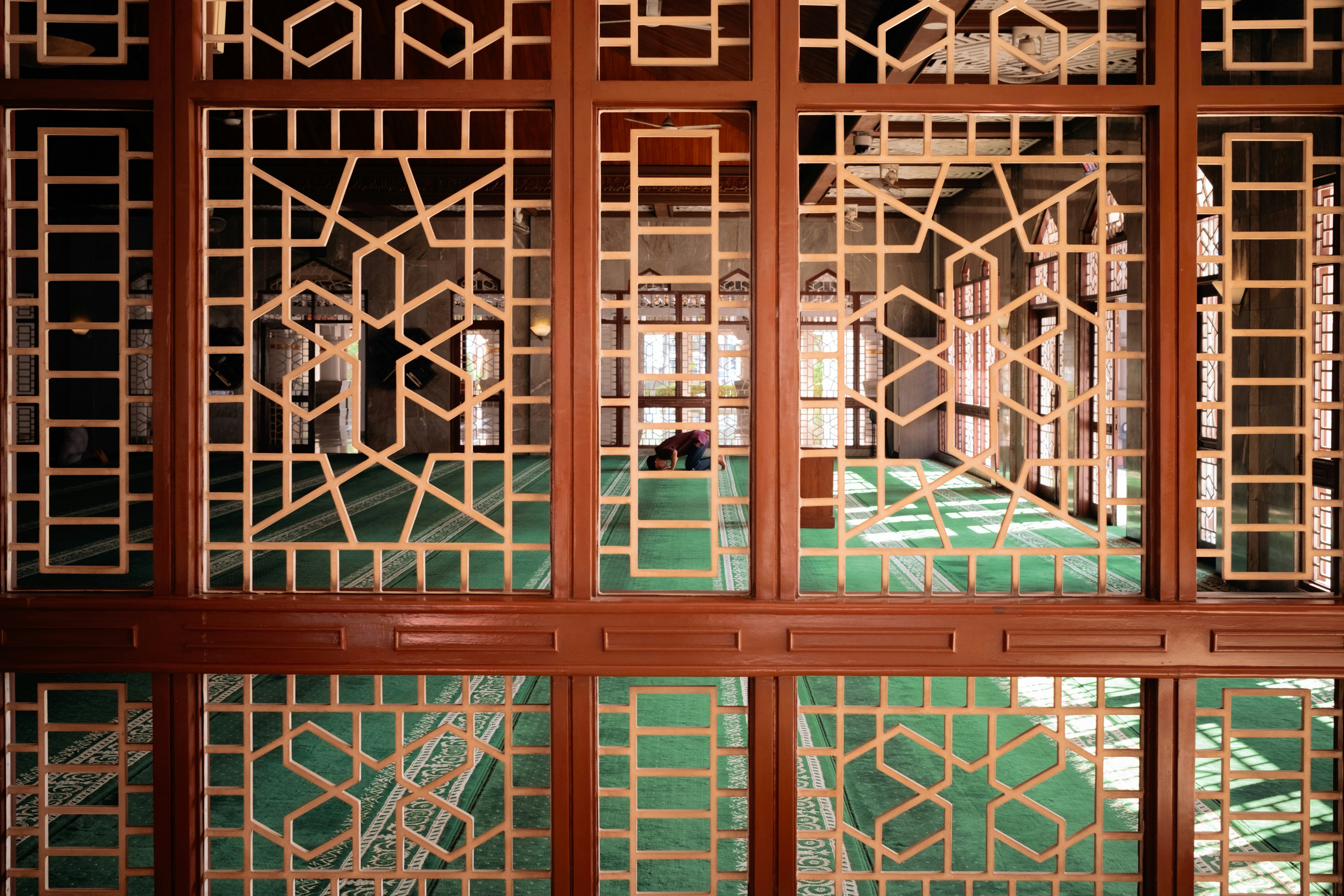 Intricate wooden screens frame a mosque's interior. photo – Free ...