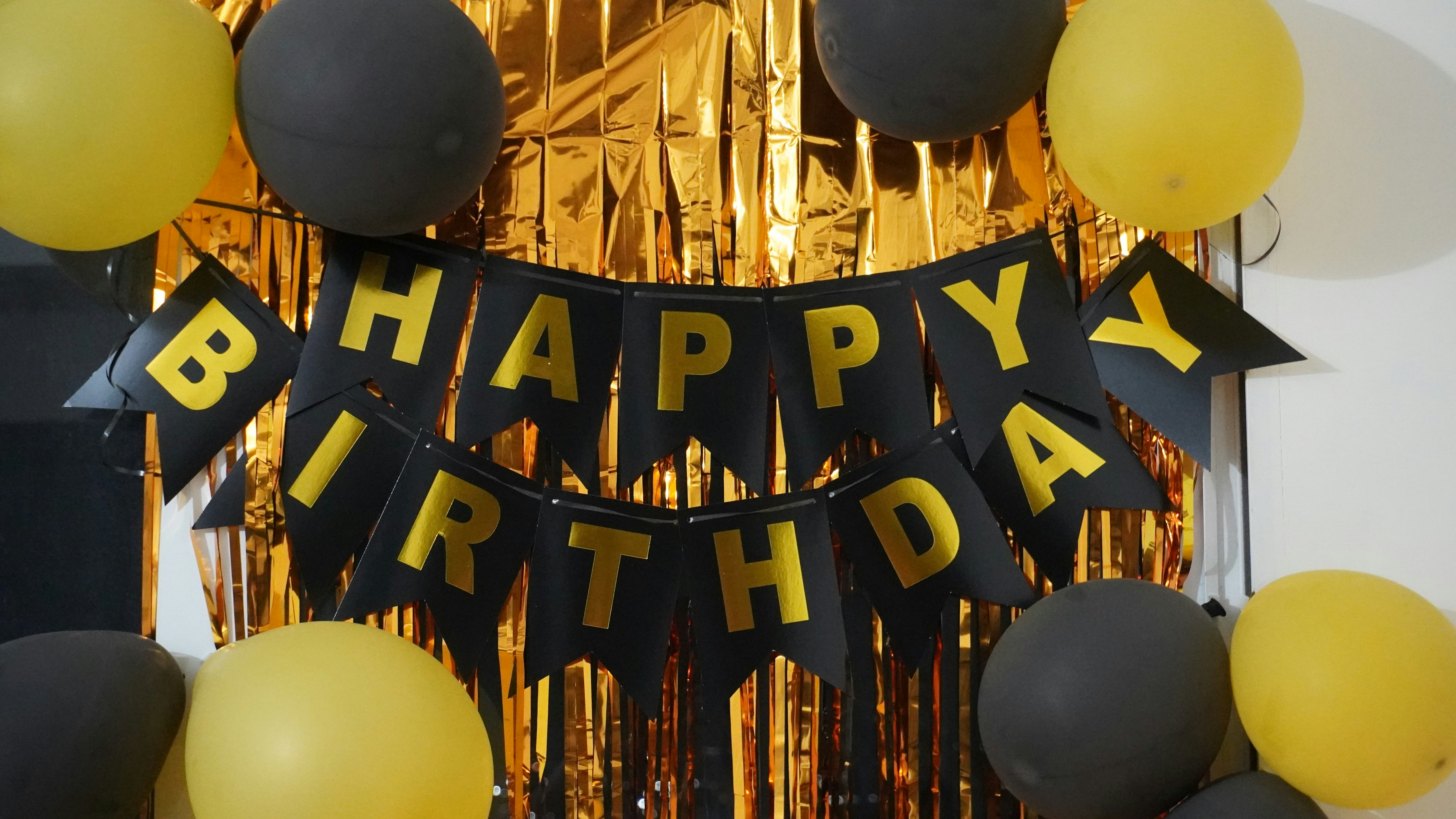 Shimmering Gold Backdrop Framing a Birthday Banner and Balloons