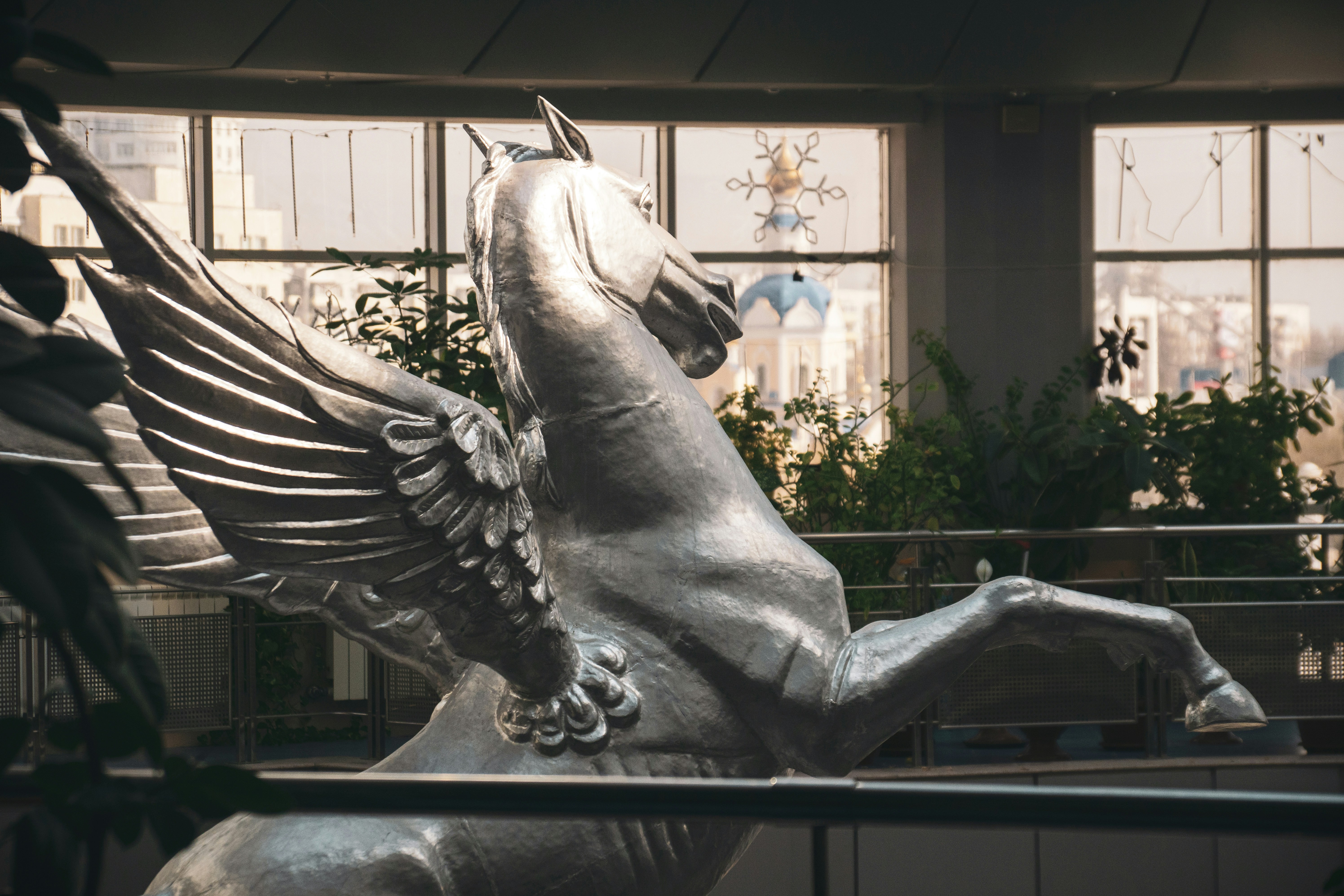 A silver pegasus statue stands tall and proud.