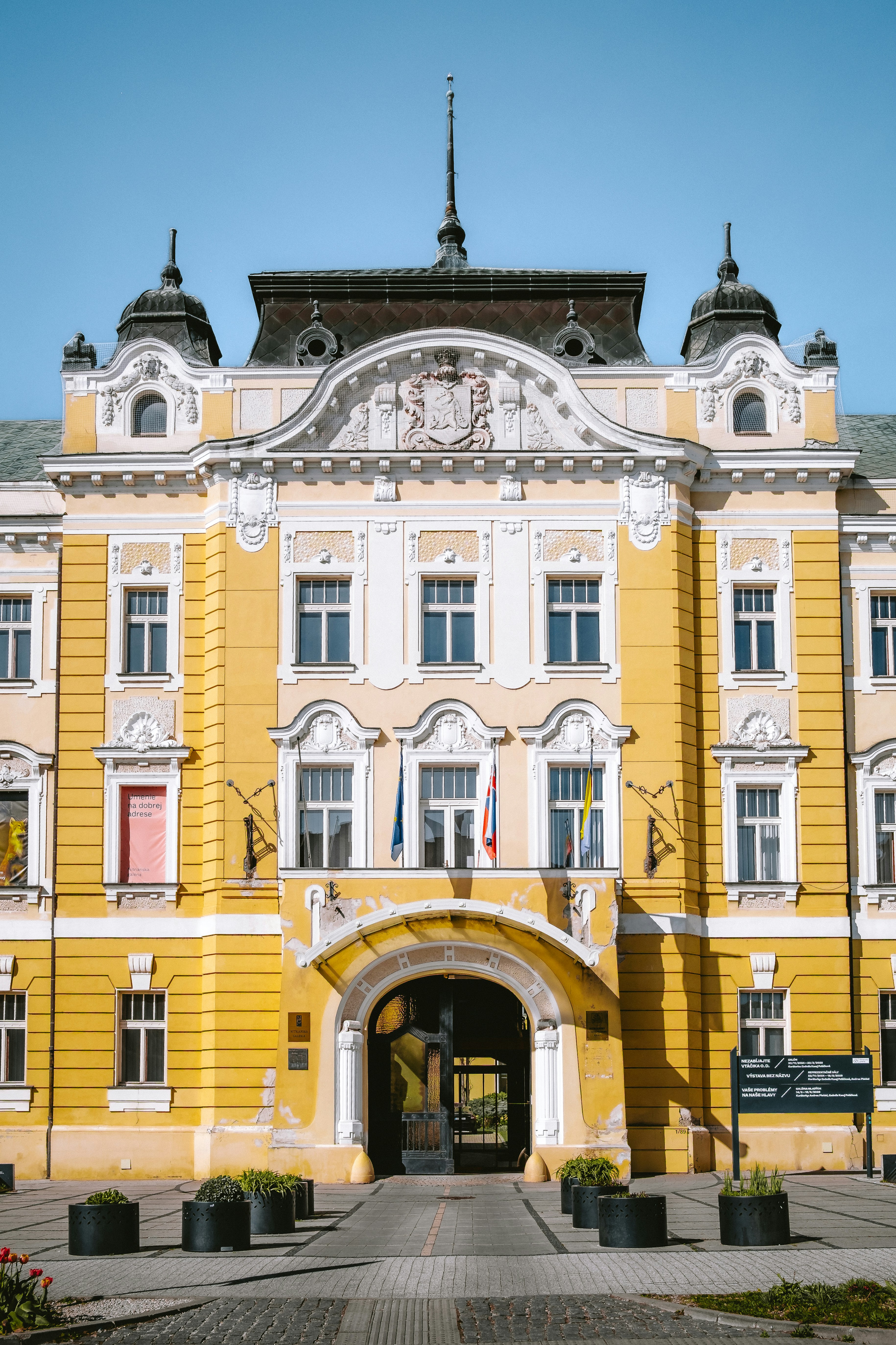 A bright yellow building with an archway. photo – Free Building Image ...