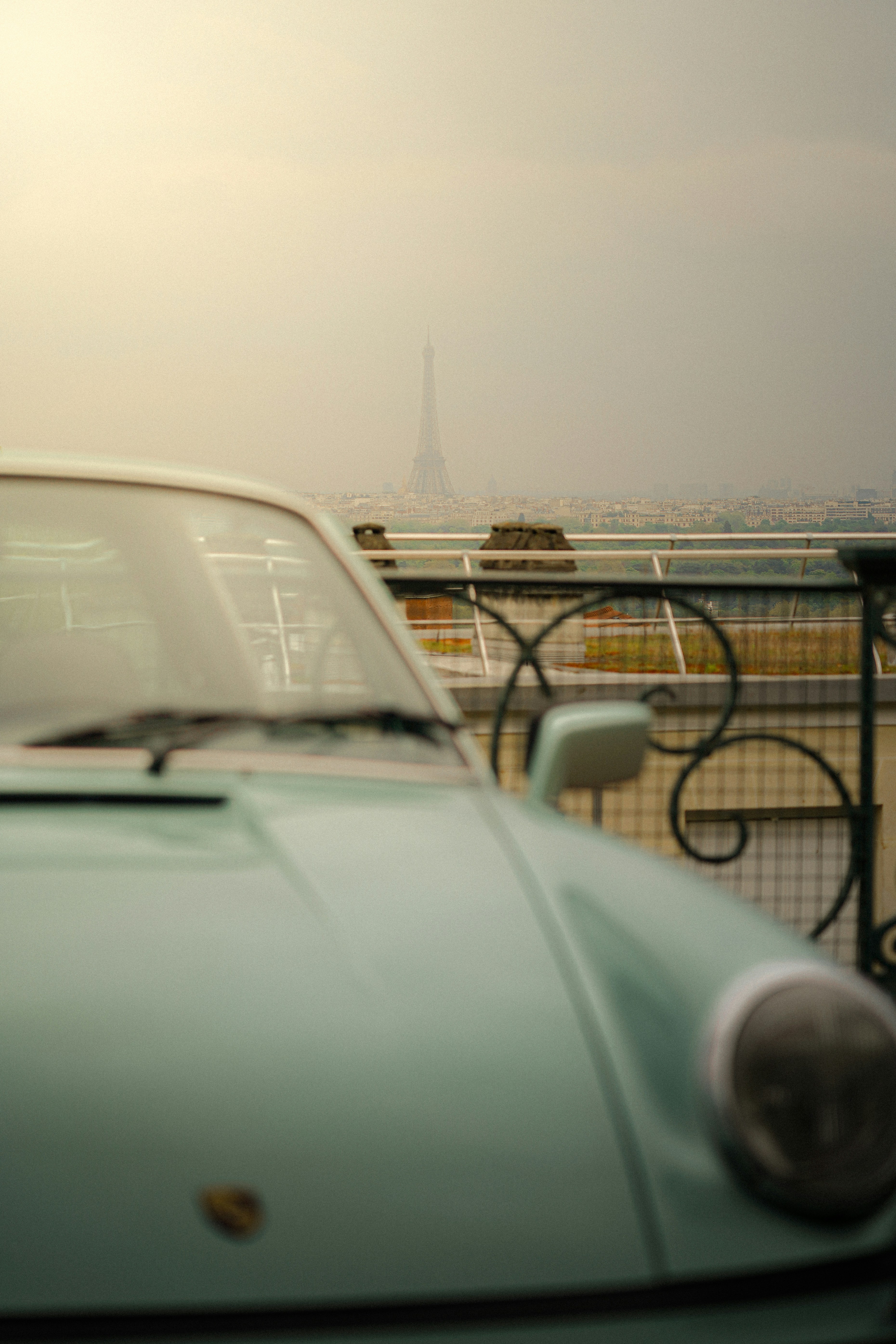 Parisian Roadside Echoes: A Mint-green Porsche Brims with Soft Light