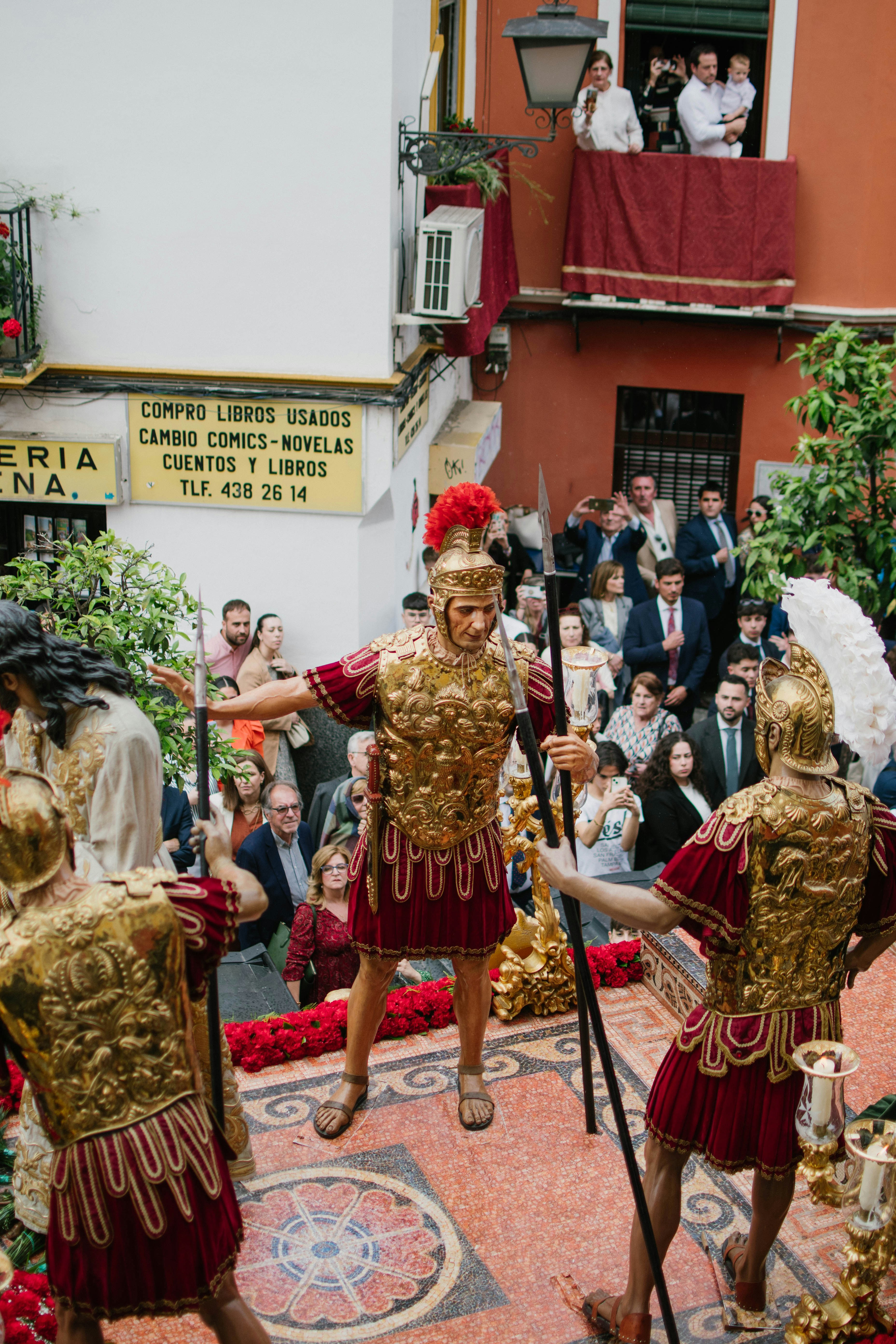 Statues and onlookers participate in a religious procession. photo ...