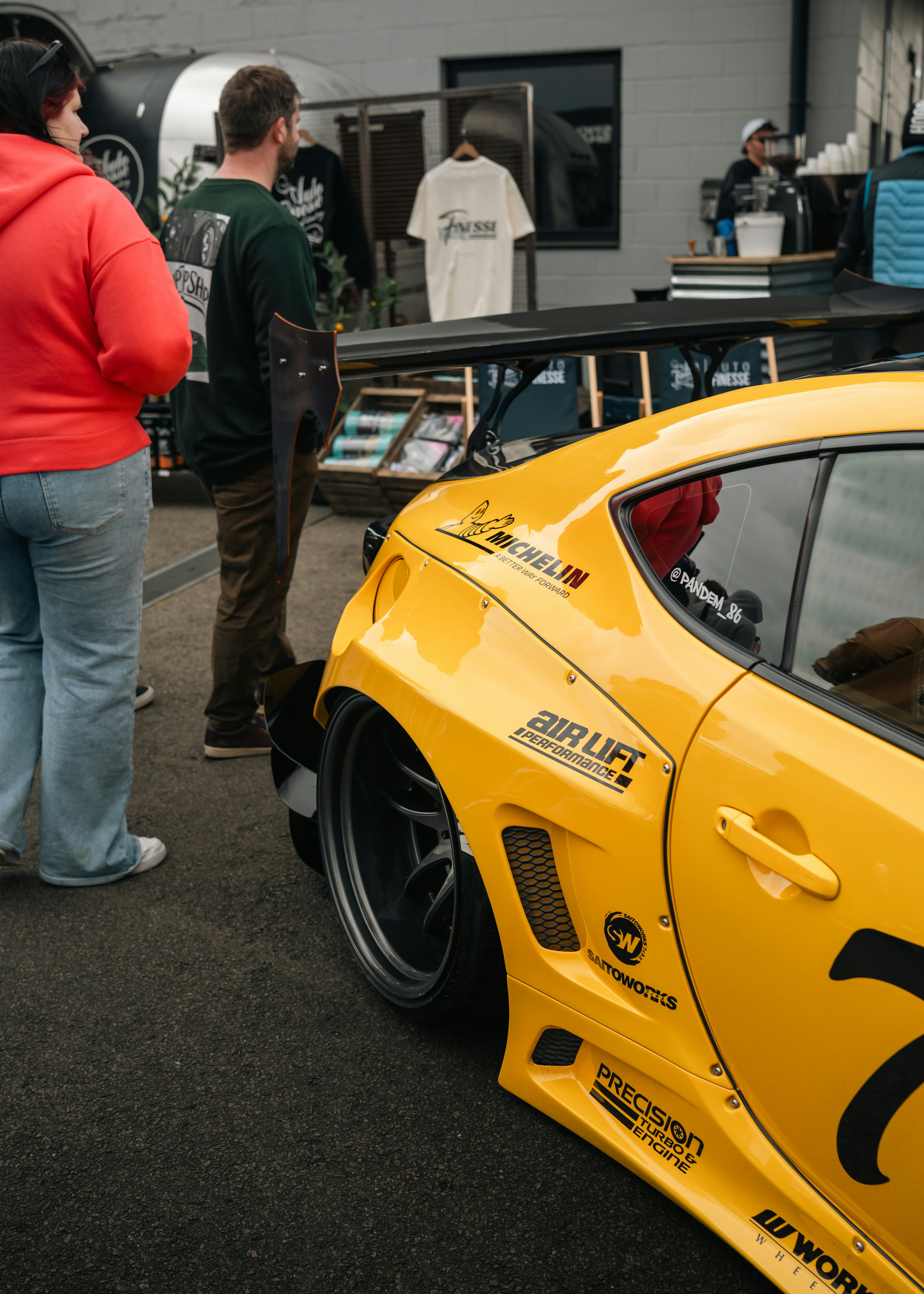 A modified yellow car at an outdoor event. photo – Free Car Image on ...
