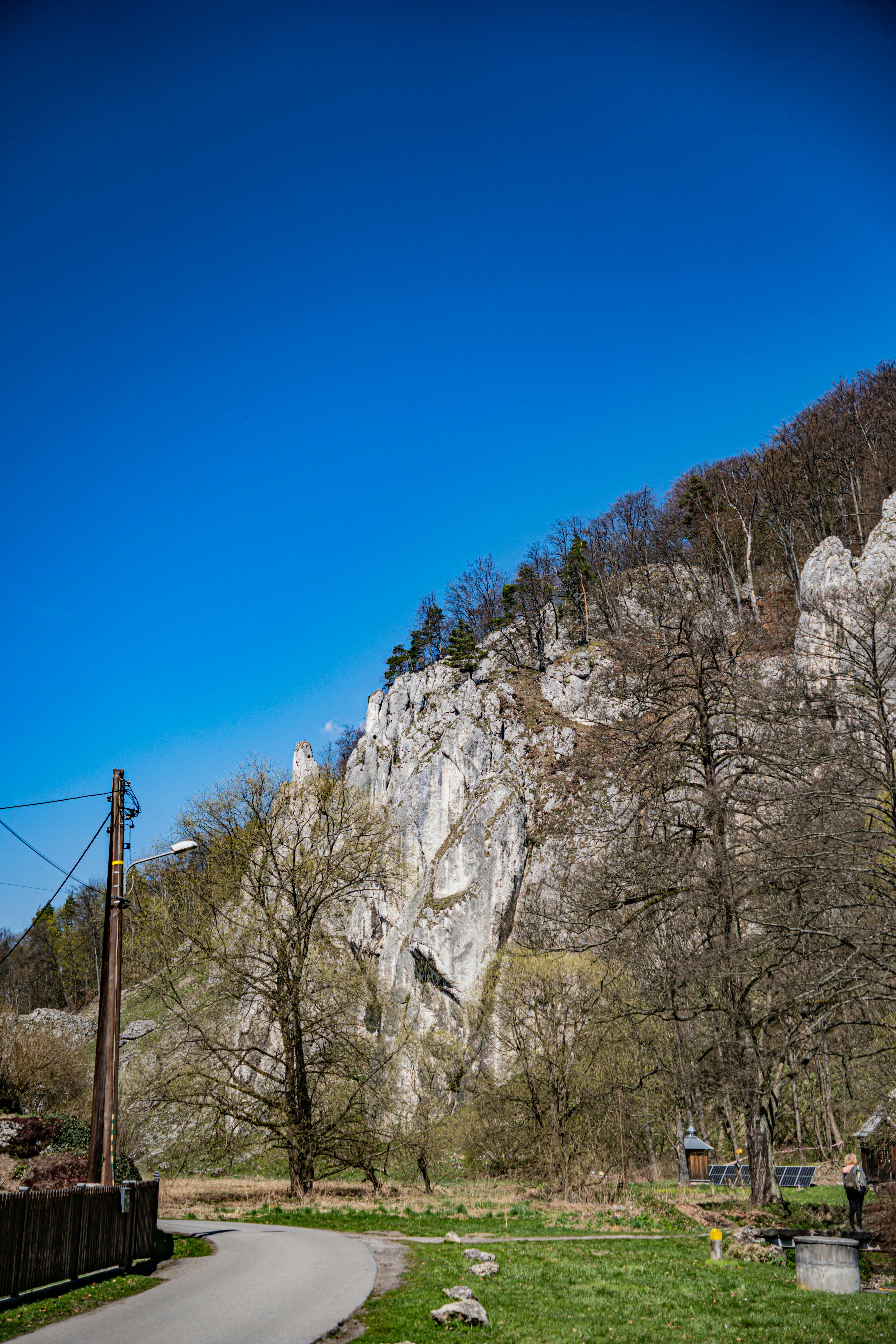 A rocky cliffside stands tall under a clear, blue sky.