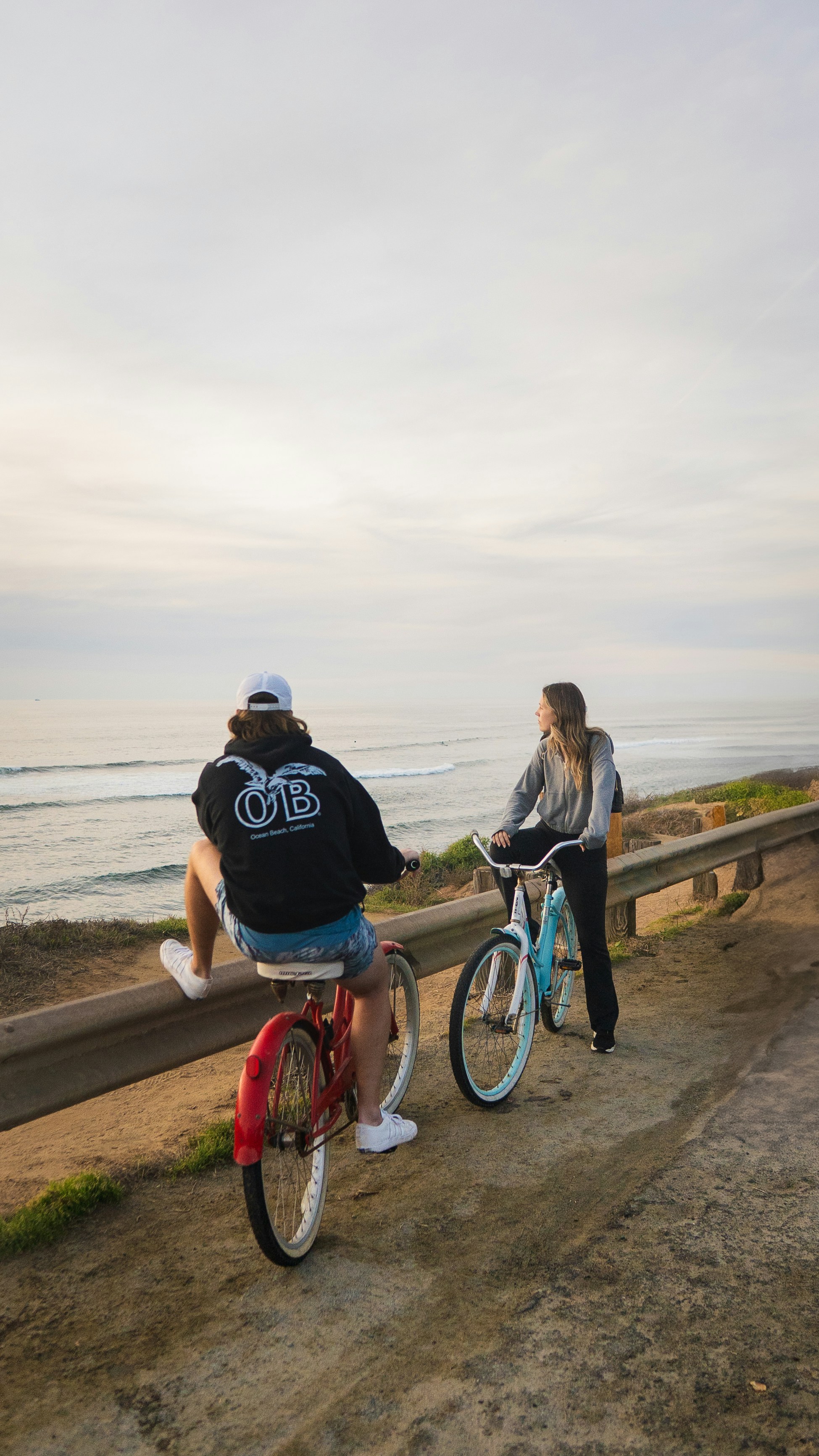 A couple looking at the sunset on bikes.