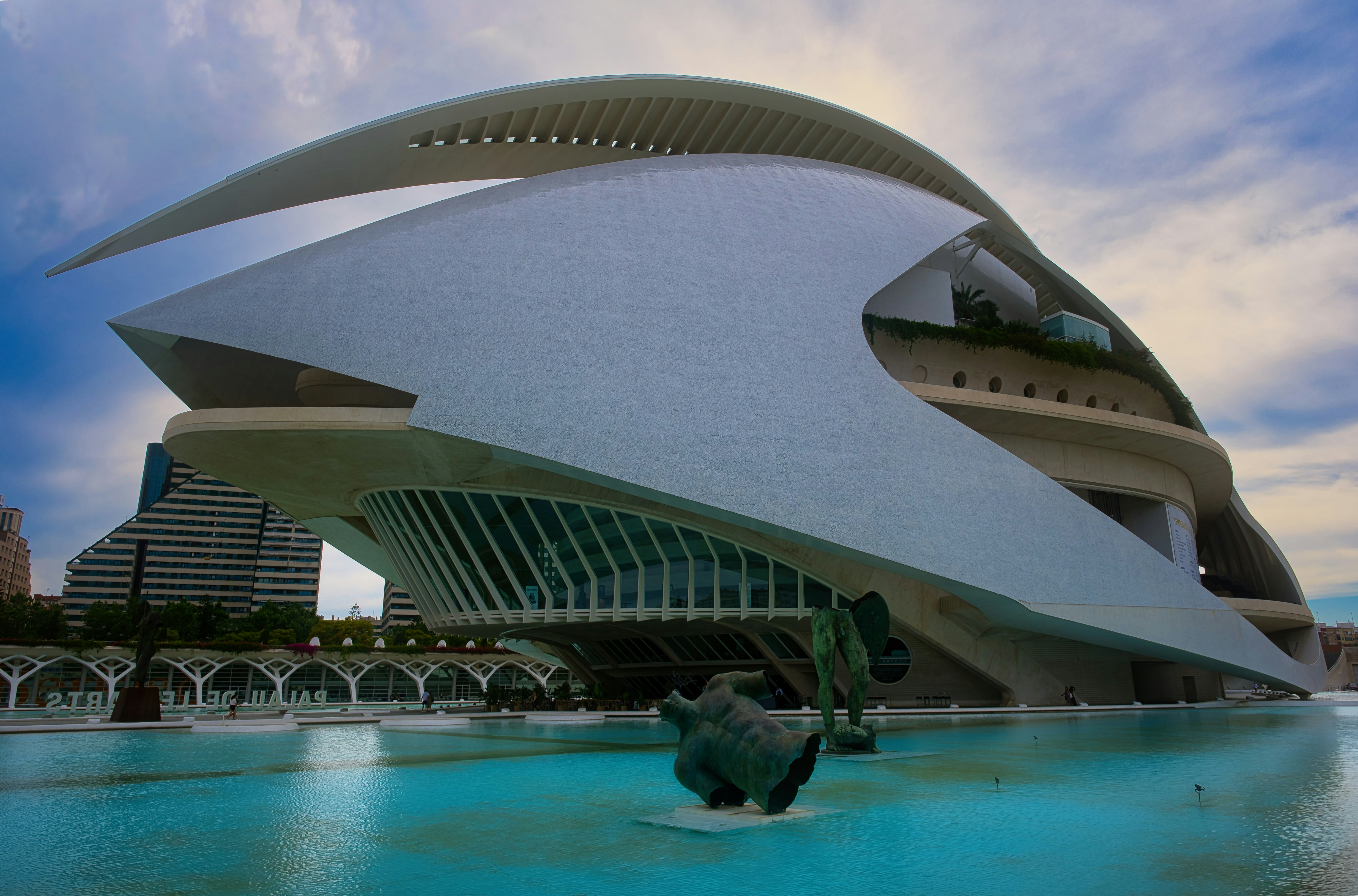 An architecturally stunning building reflects in water. photo – Free ...