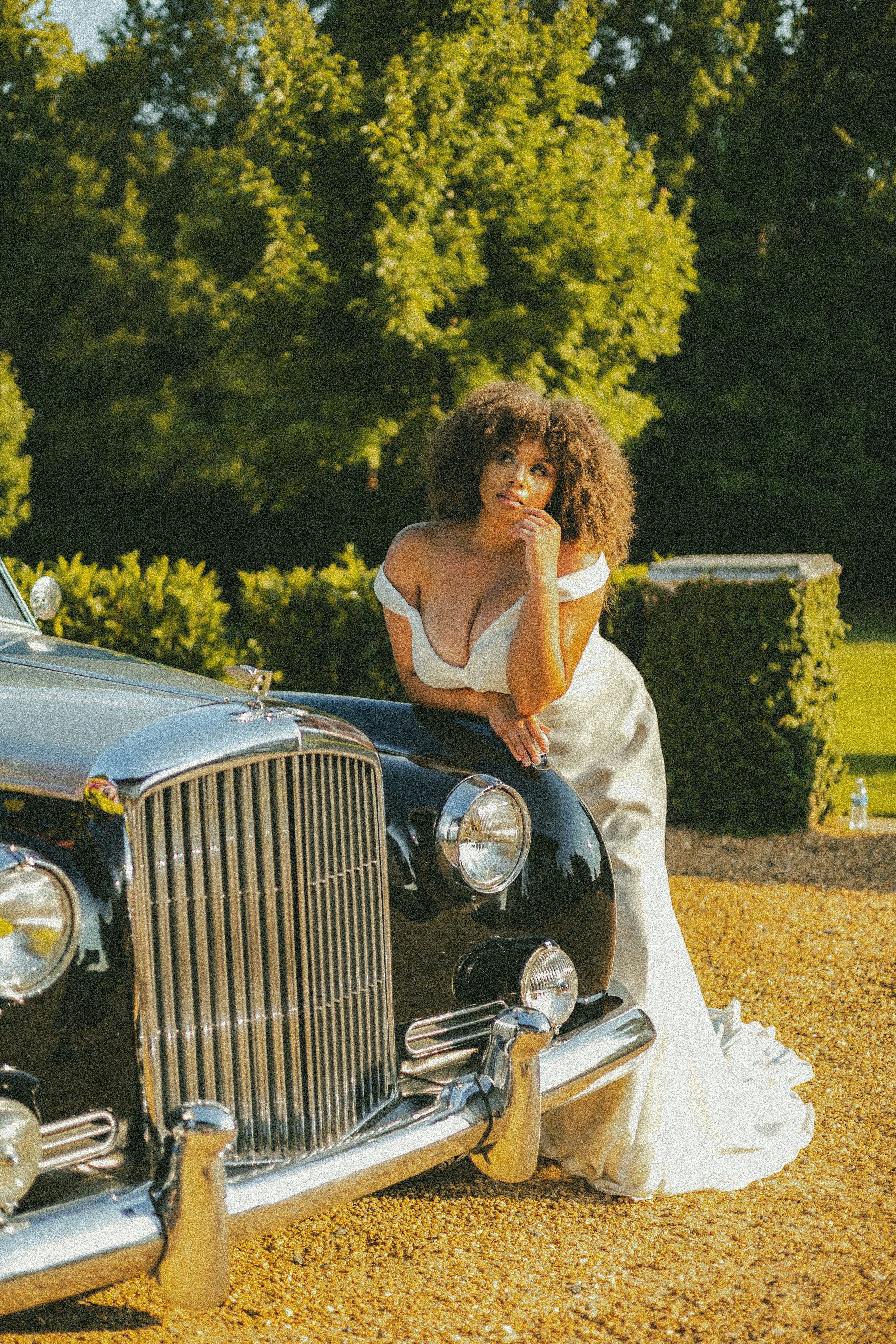 Gleam and Gown: A Bridal Moment Beside a Vintage Black Sedan