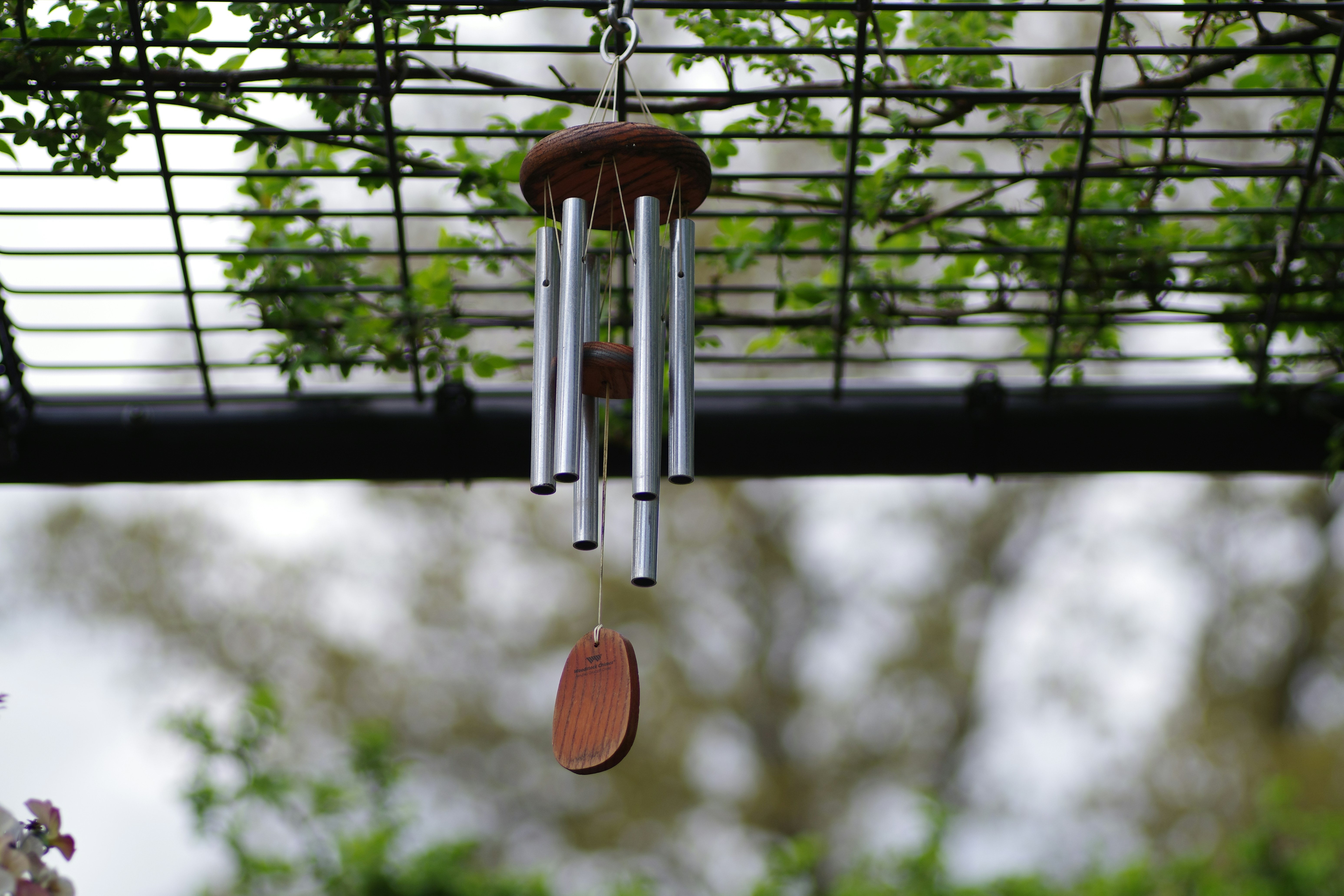 Hanging Wind Chimes in a Garden Alcove