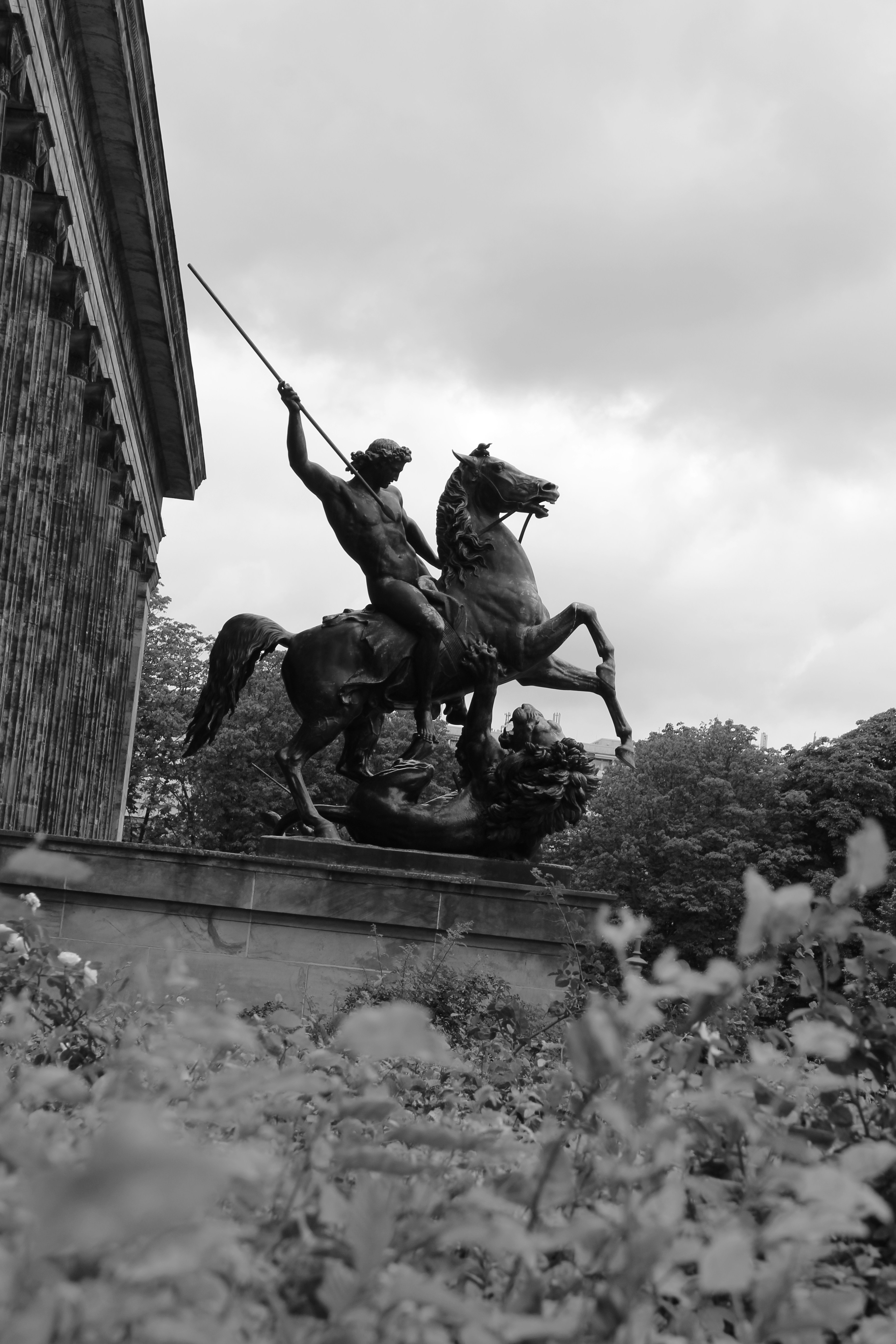 A statue depicts a man on horseback slaying a beast. photo – Free ...